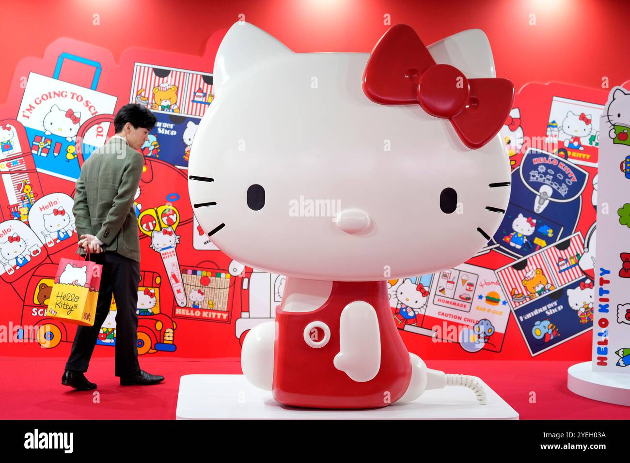 A visitor looks at giant Hello Kitty display at the exhibition "As I ...