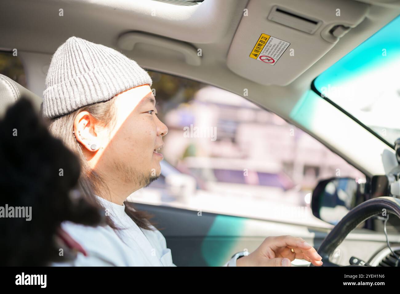 A Korean man in his 30s is driving a car in Pyeongnae-dong, Namyangju ...