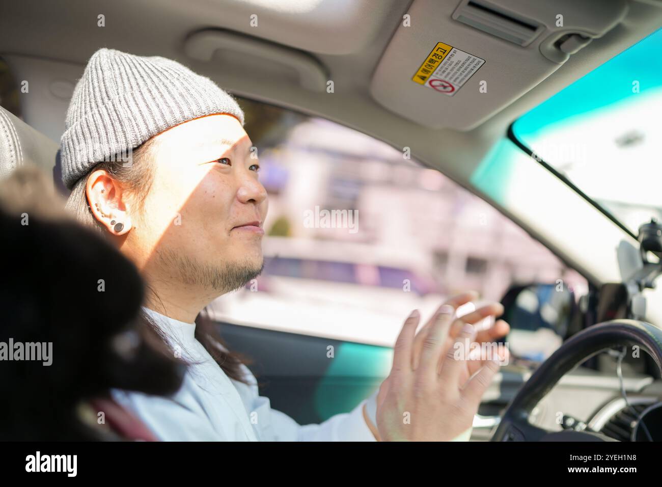 A Korean man in his 30s is driving a car in Pyeongnae-dong, Namyangju ...