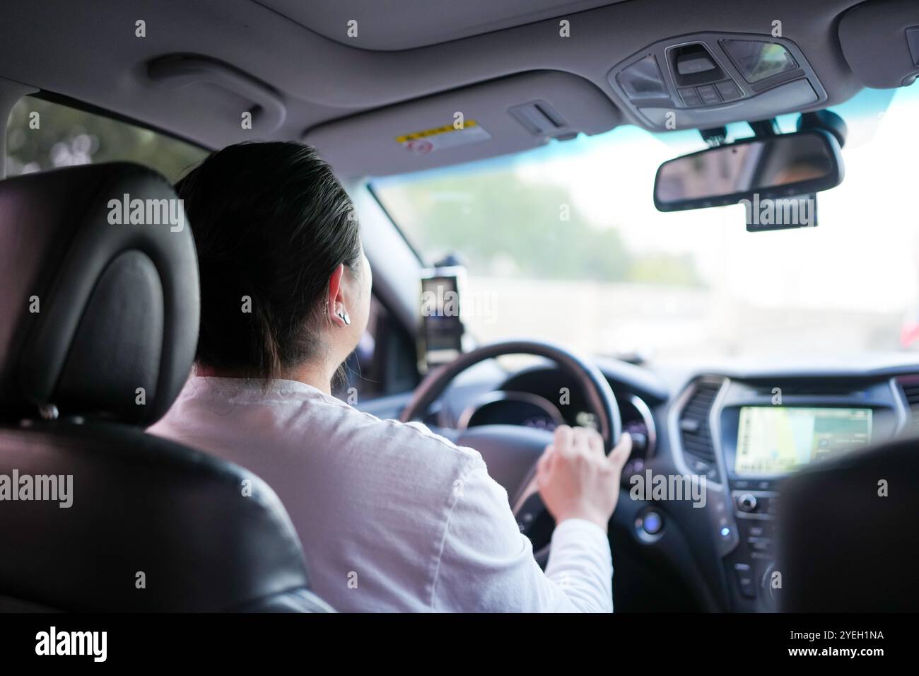 A Korean man in his 30s is driving a car in Pyeongnae-dong, Namyangju ...
