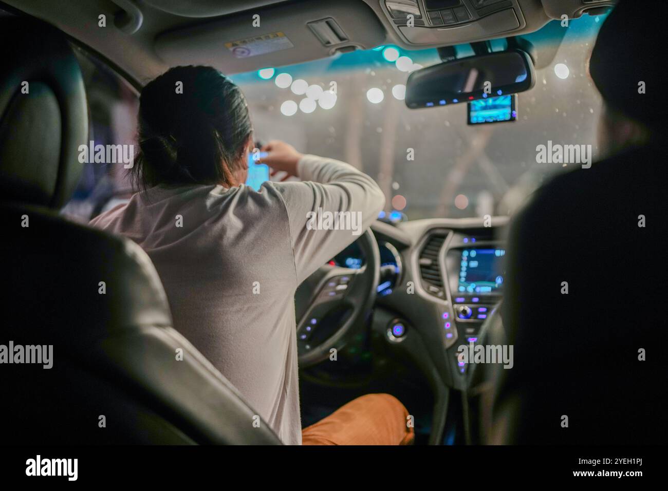 A Korean man in his 30s is driving a car in Pyeongnae-dong, Namyangju ...