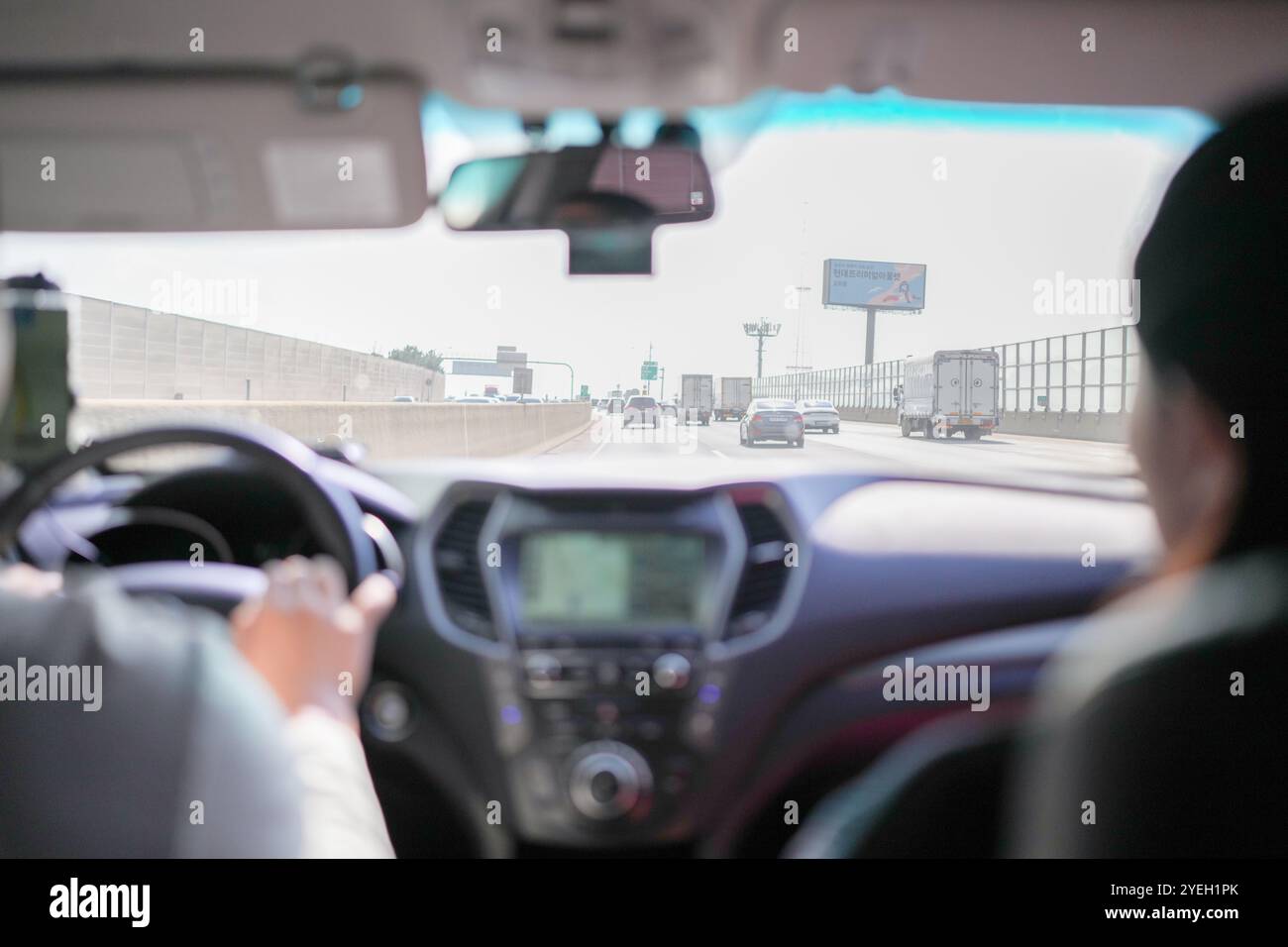 A Korean man in his 30s is driving a car in Pyeongnae-dong, Namyangju ...