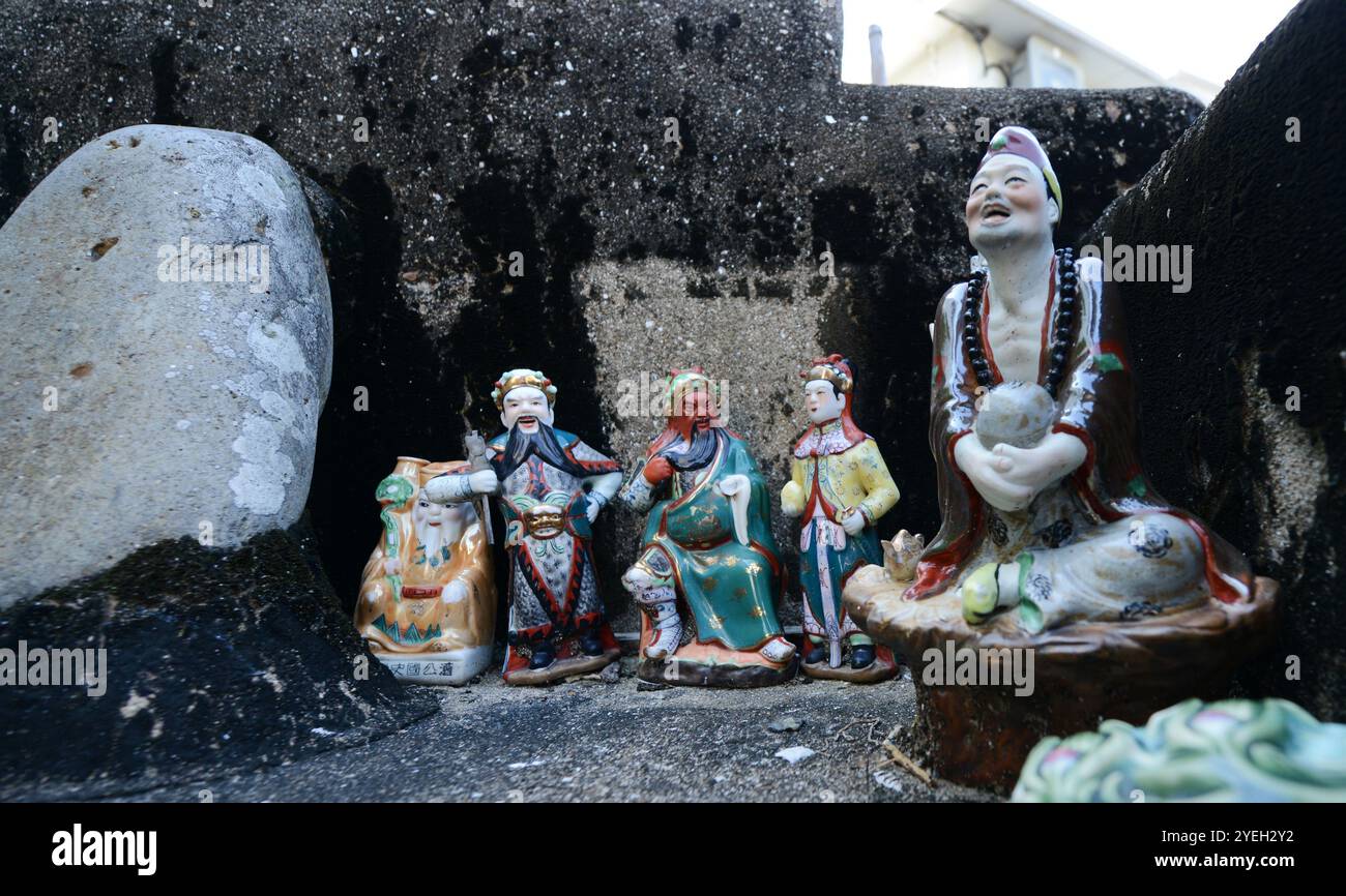 Small statues of religious figures at a small temple in Tai O village ...