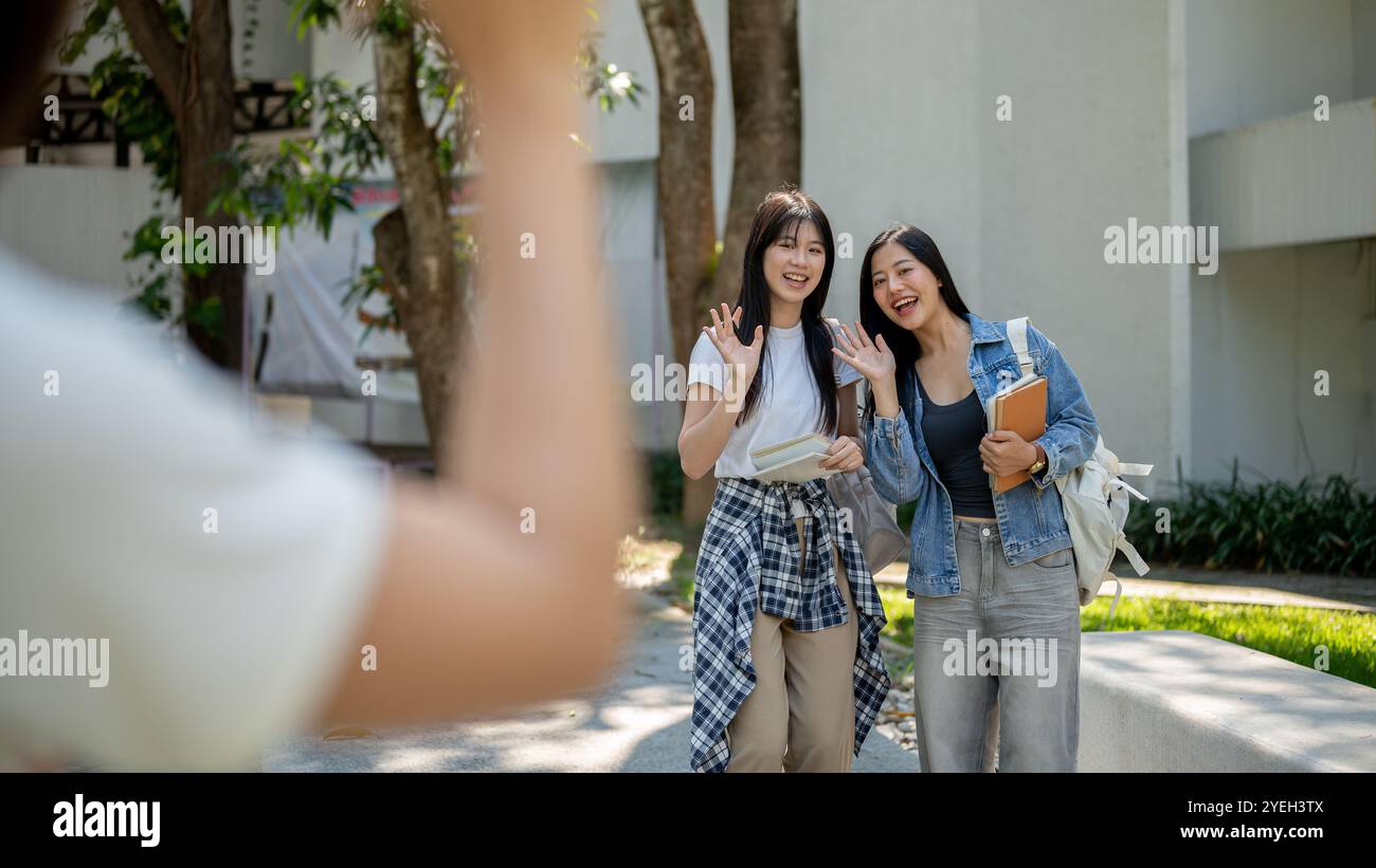 Two pretty and friendly Asian female college students are saying ...