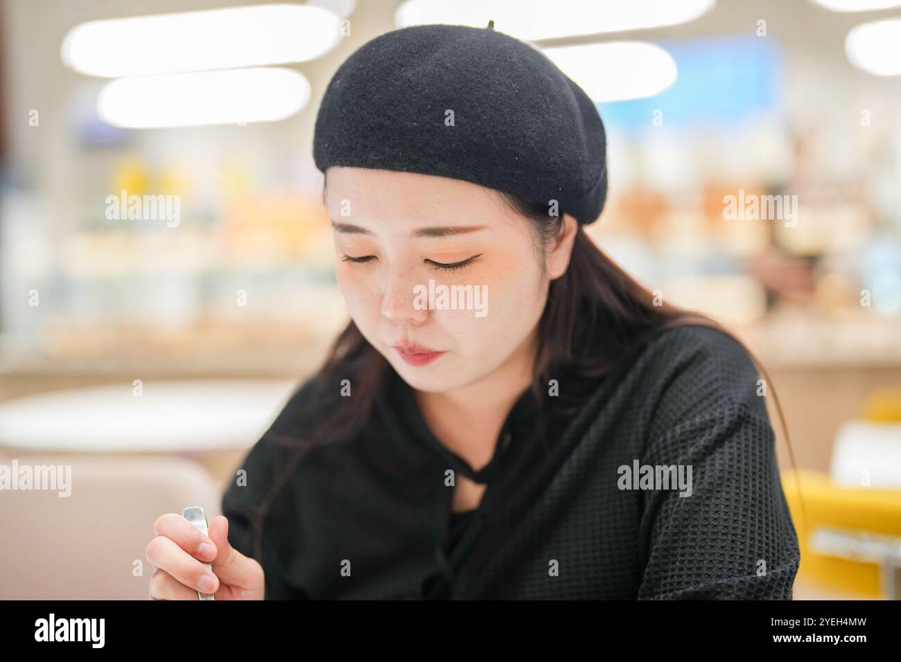 A Japanese woman in her 30s is enjoying a meal at a stylish cafe located in Gosan-ro, Namyangju ...