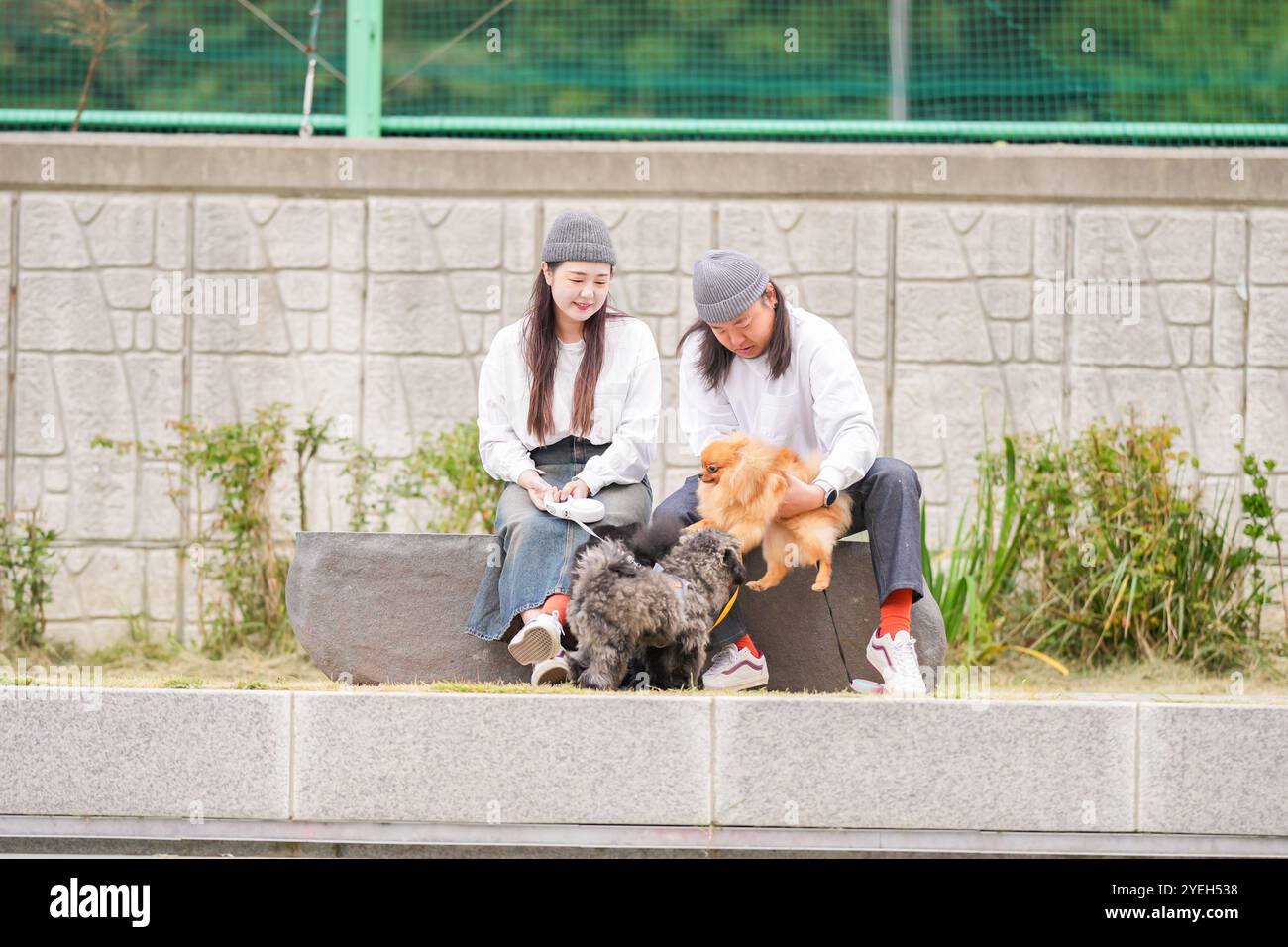 A Korean man and a Japanese woman, both in their 30s, are walking three ...