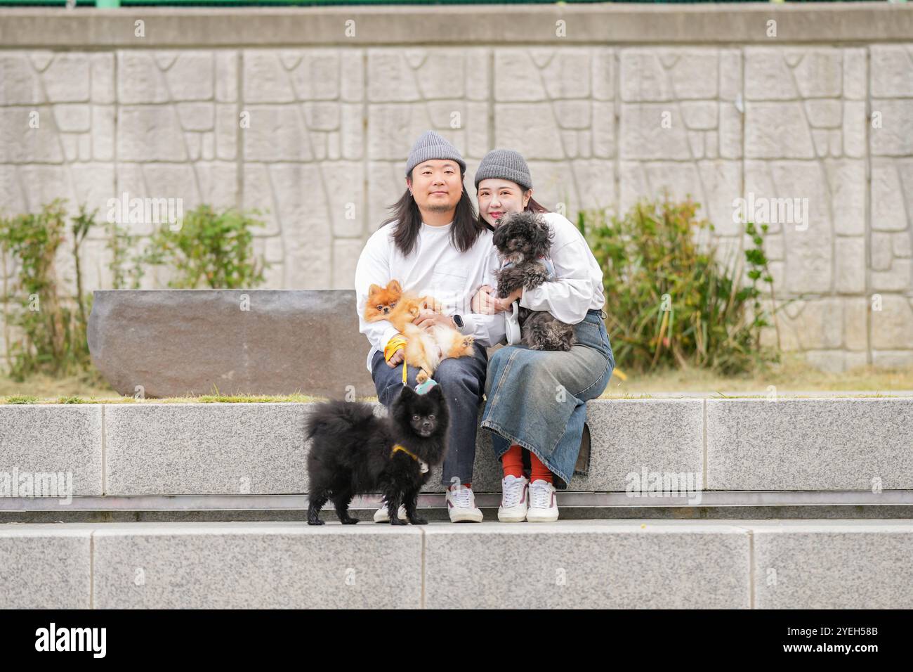 A Korean man and a Japanese woman, both in their 30s, are walking three ...