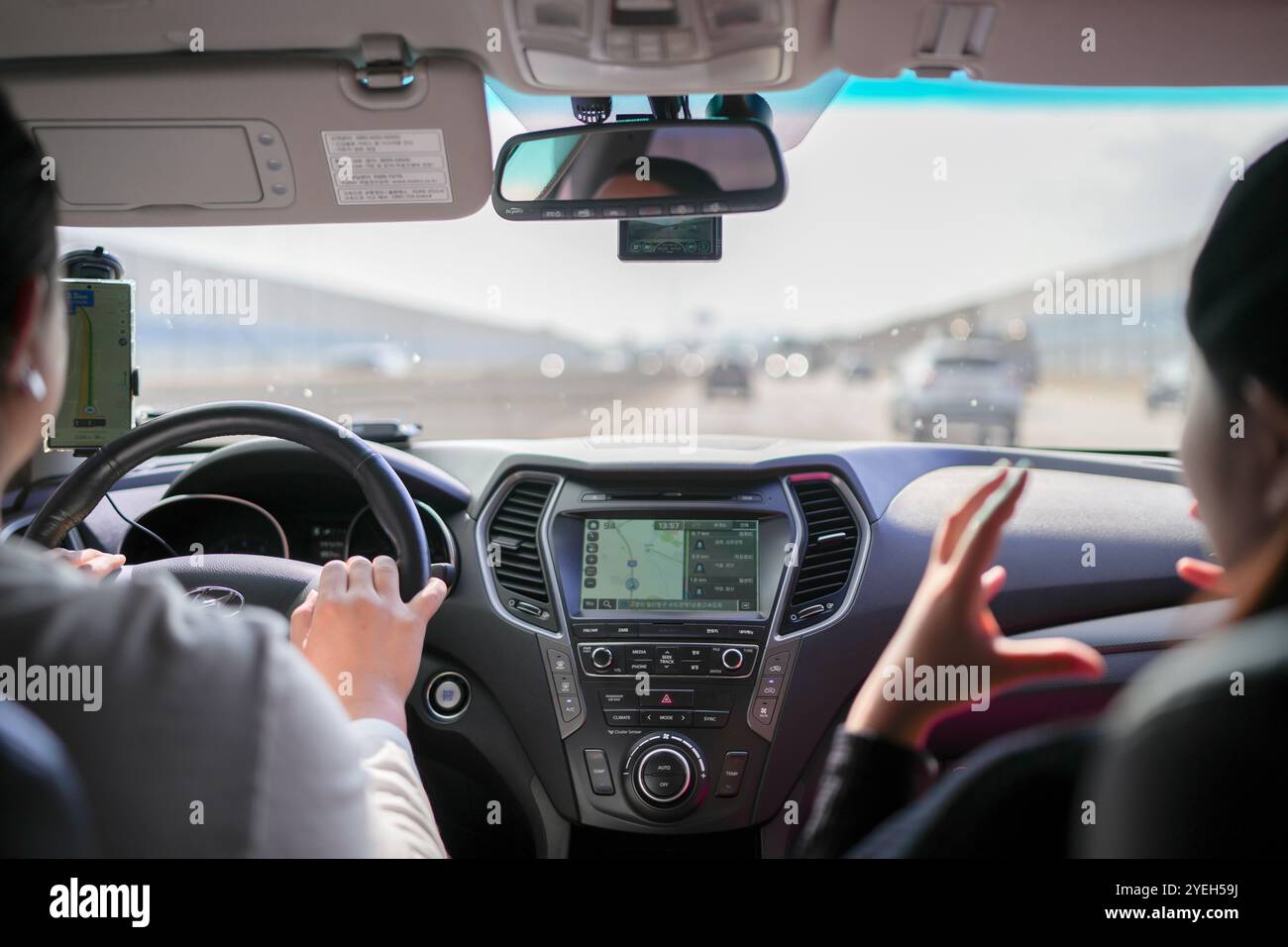 A Korean man in his 30s is driving a car in Pyeongnae-dong, Namyangju ...