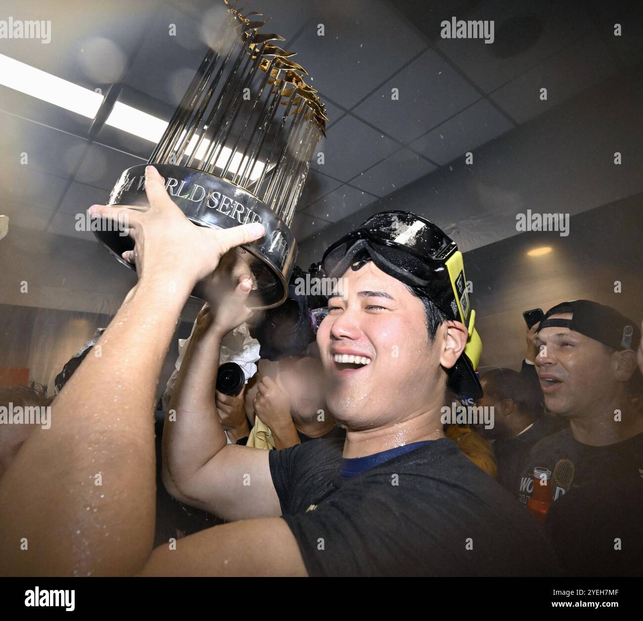 Los Angeles Dodgers slugger Shohei Ohtani raises the trophy as the team ...