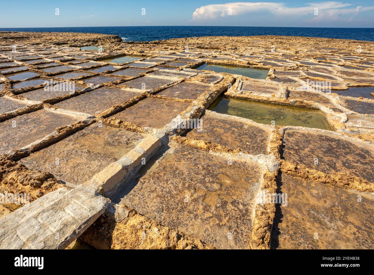 Picturesque scene of Zabbar Bay's traditional salt pans on the beach of ...