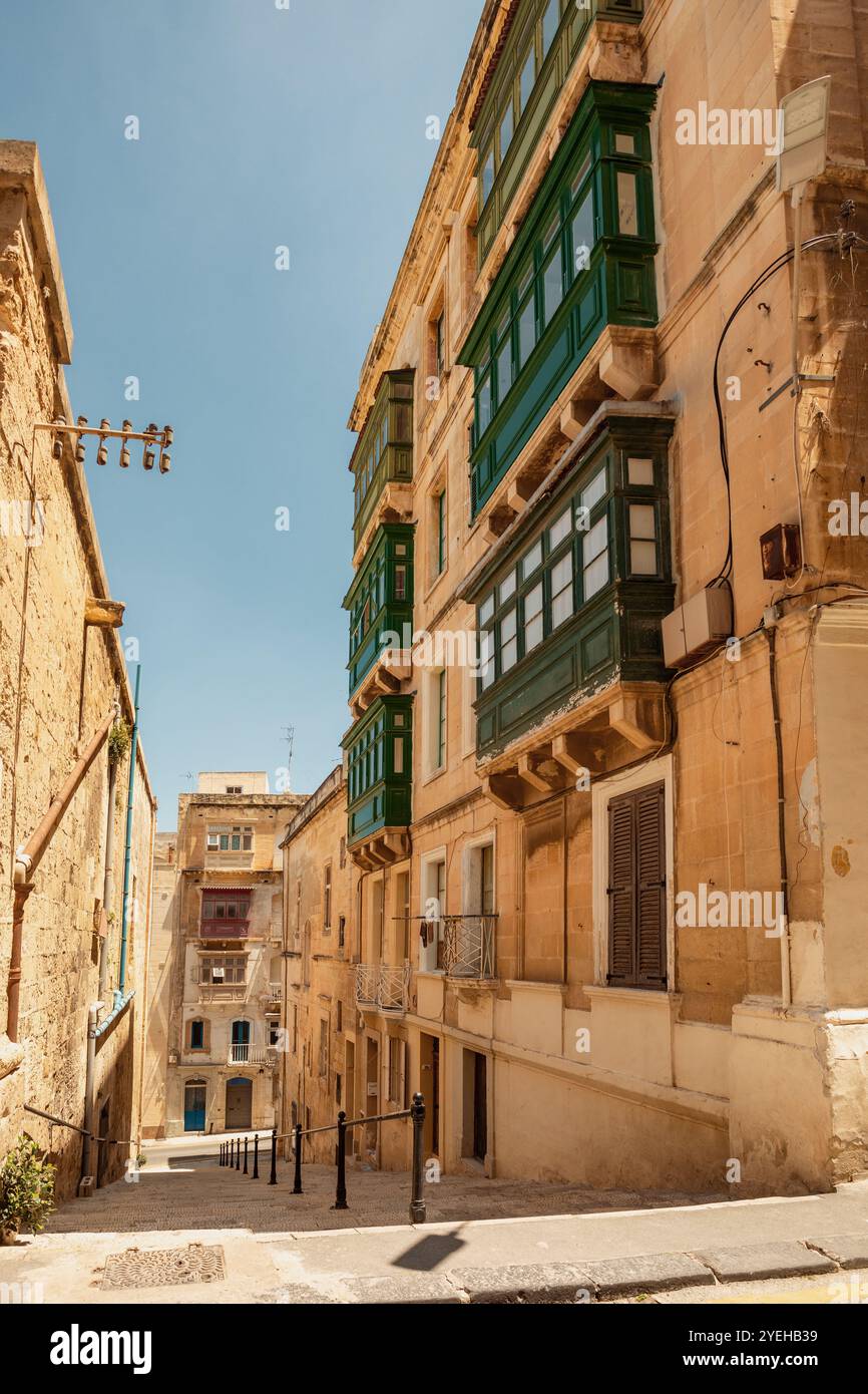 Narrow, street in Valletta, ancient core reveals historic sandstone ...