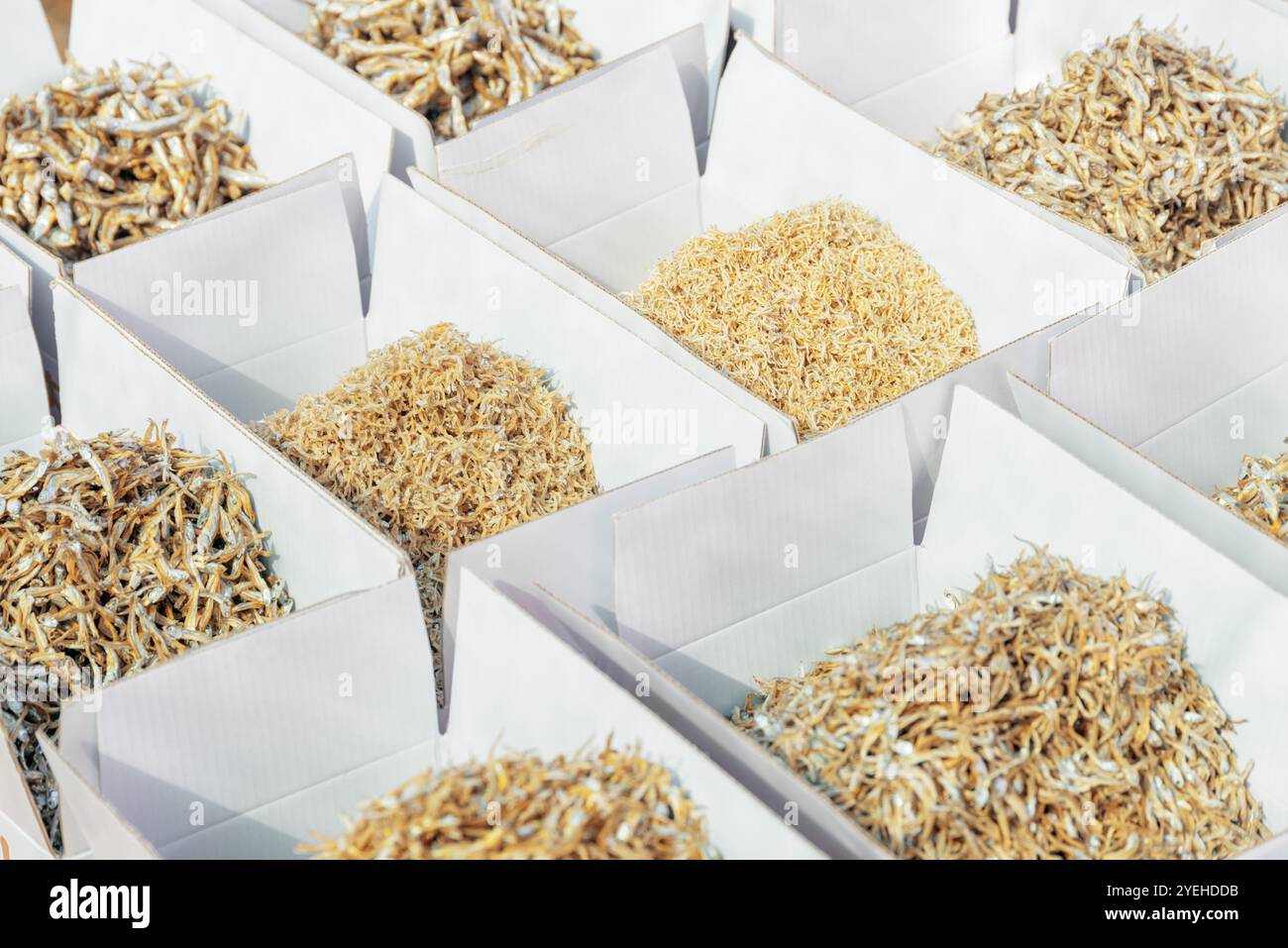 Small dried fish in boxes at fish market Stock Photo - Alamy