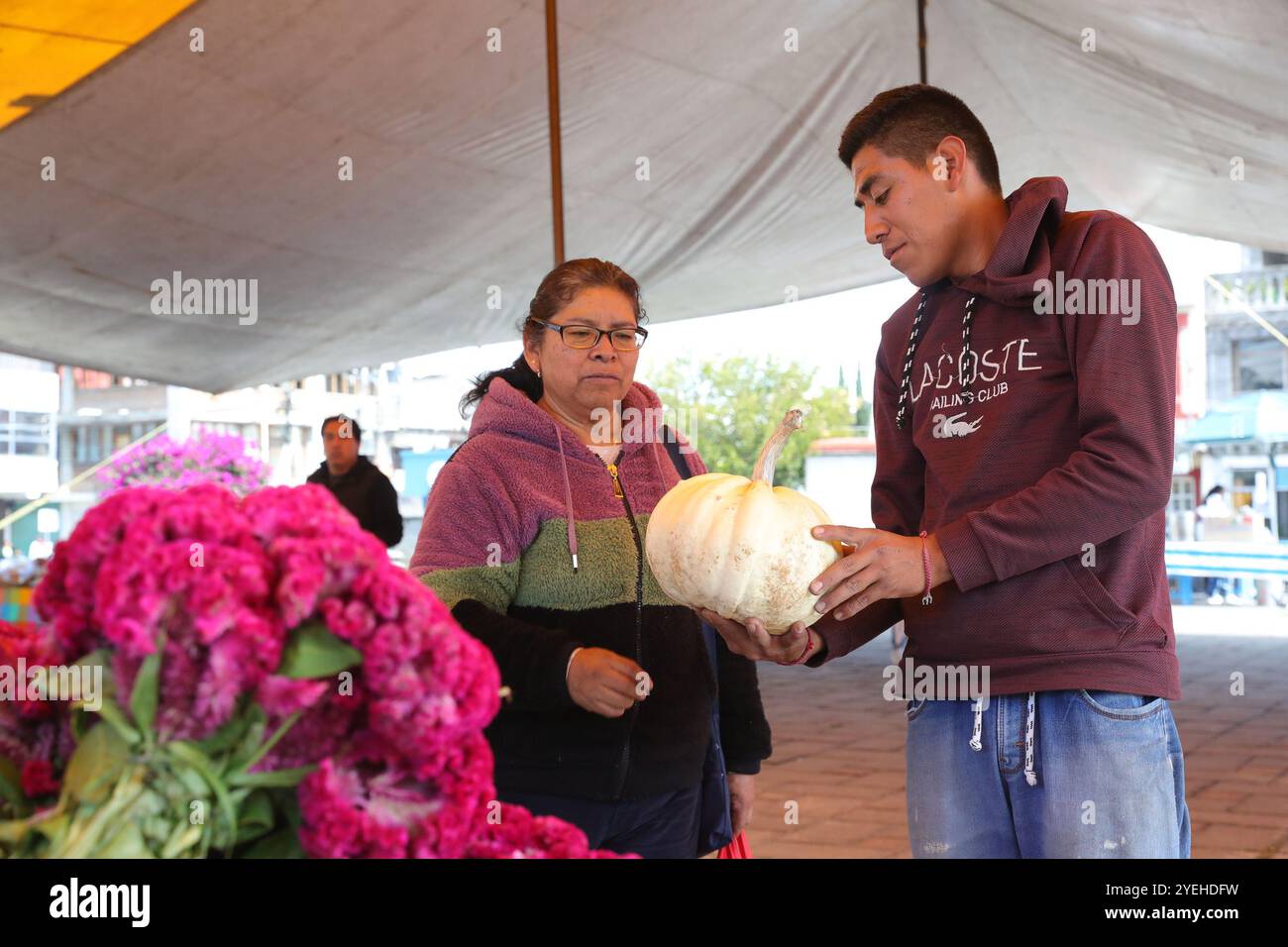 Non Exclusive: A Vendor offering a pumpkin to a woman on the occasion ...