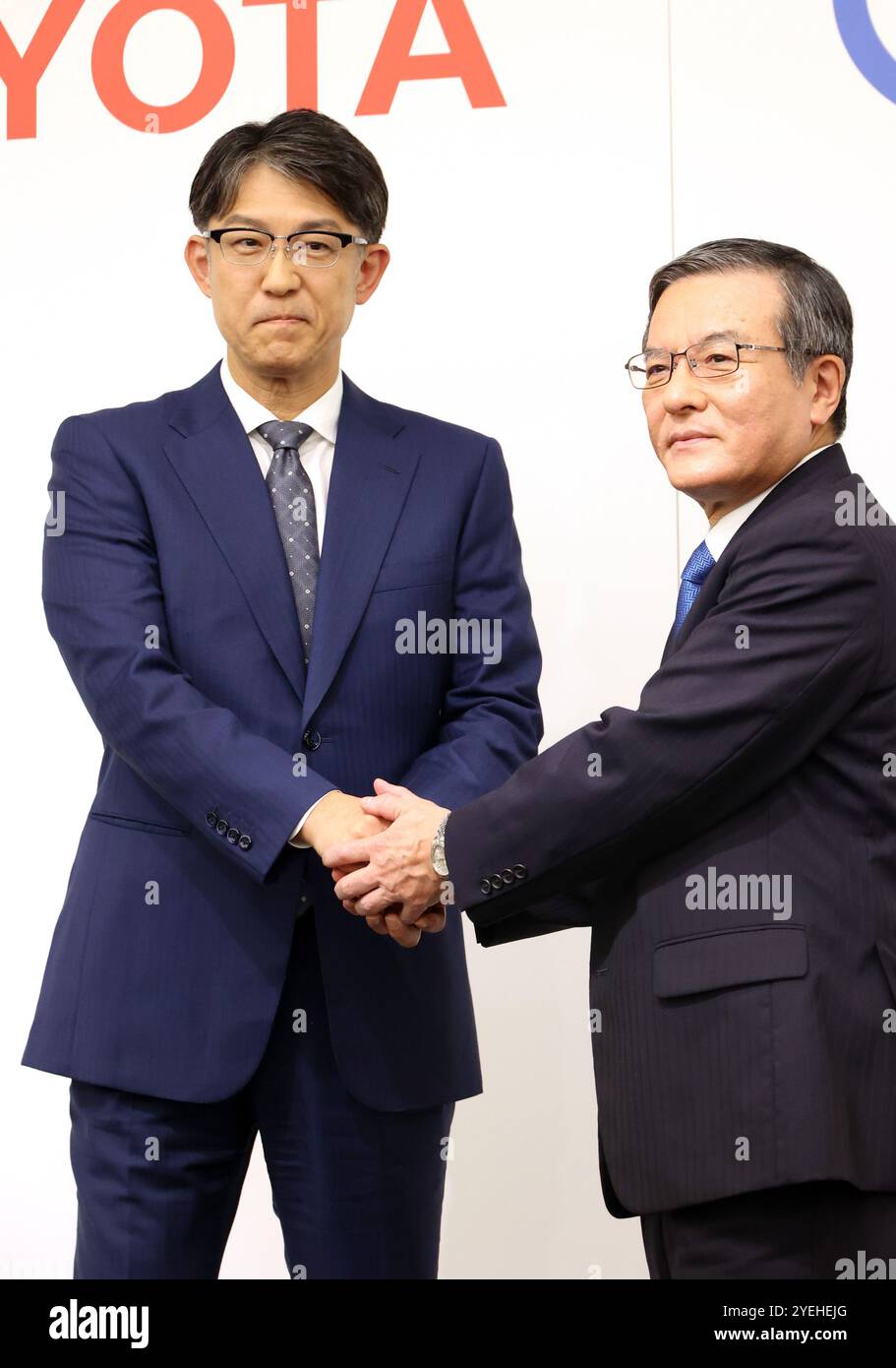 October 31, 2024, Tokyo , Japan - Japan's auto giant Toyota Motor president Koji Sato (L) shakes ...