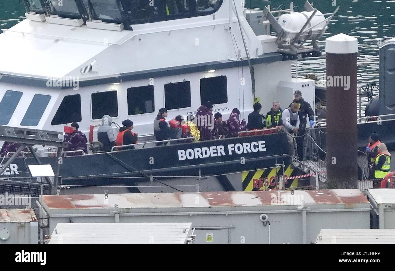 A group of people thought to be migrants are brought in to Dover, Kent ...
