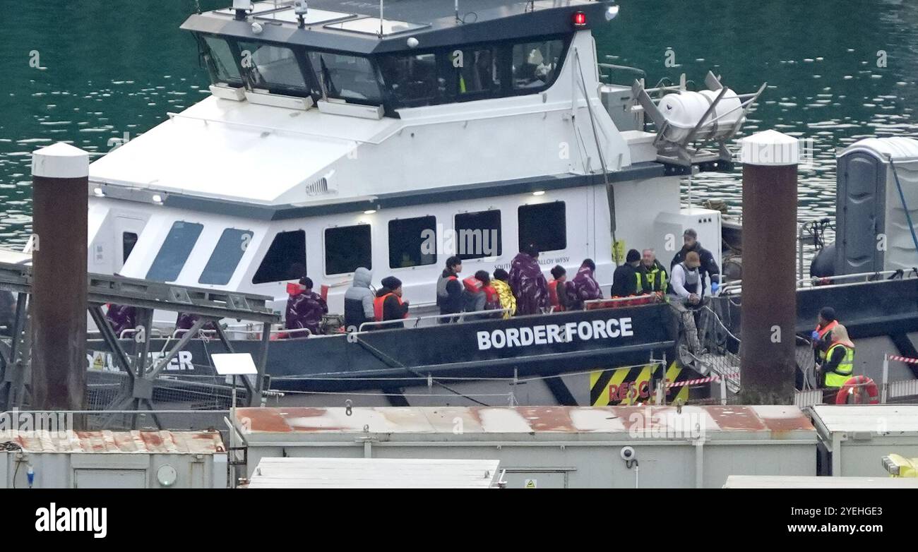 A group of people thought to be migrants are brought in to Dover, Kent ...