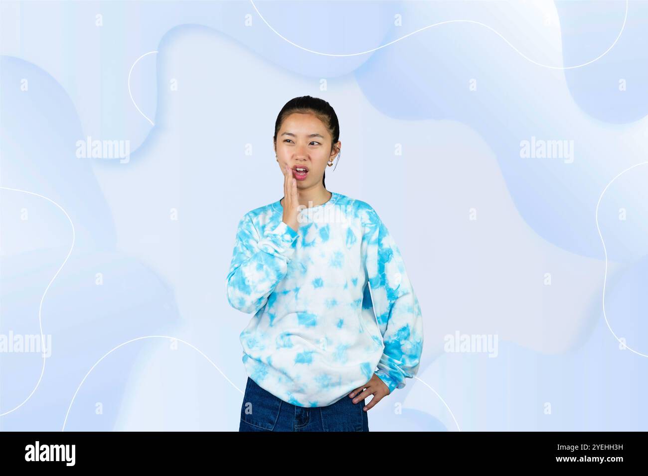 Yougn Asian girl with blue dress points and gives various expression ...