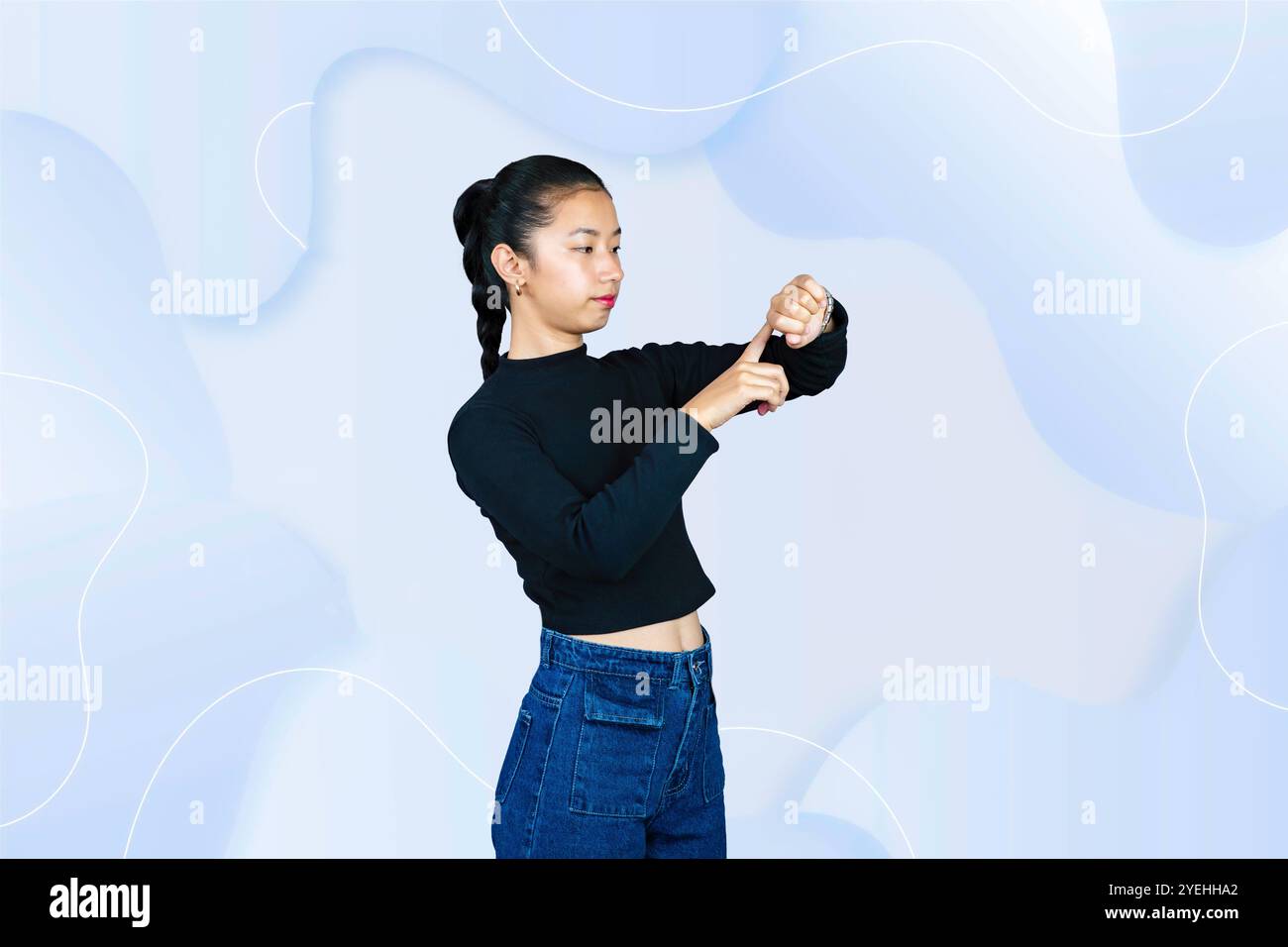 Young Asian Girl gives gestures of pointing presenting, expression of ...