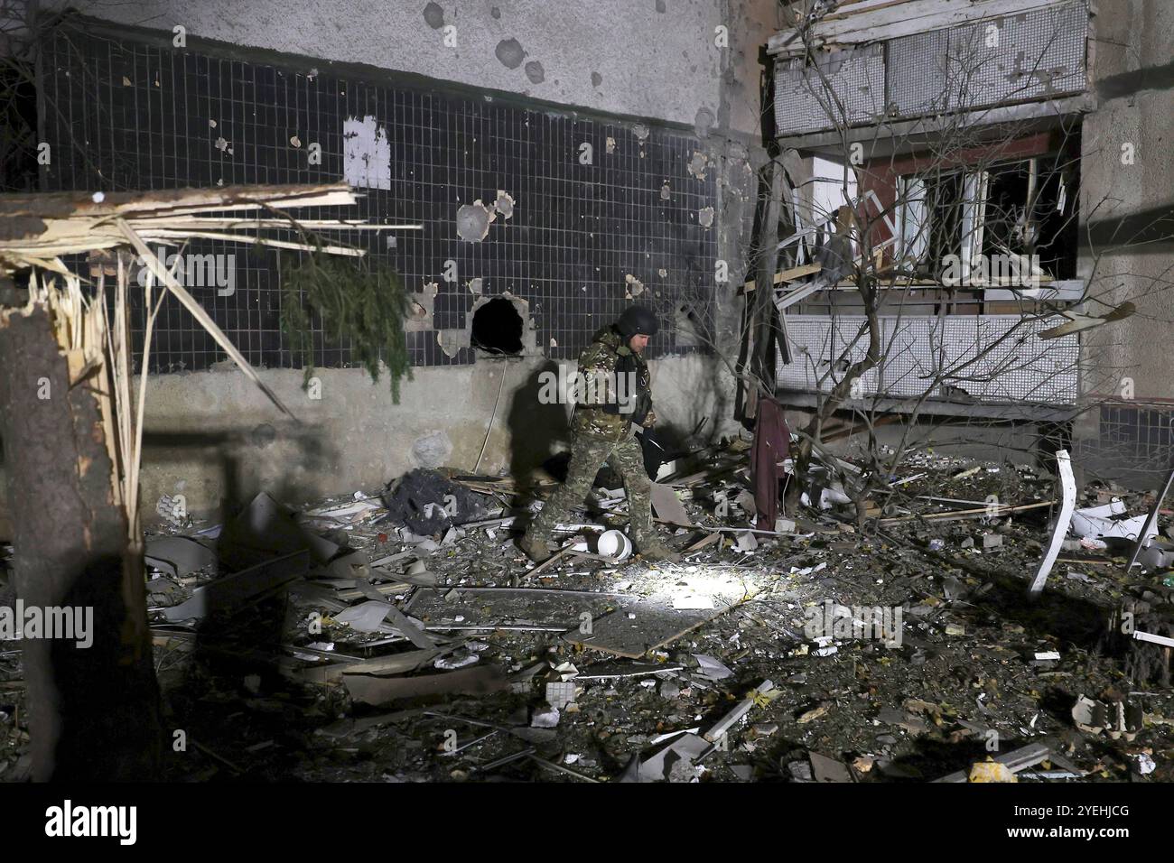 KHARKIV, UKRAINE - OCTOBER 31, 2024 - A serviceman with a torch ...