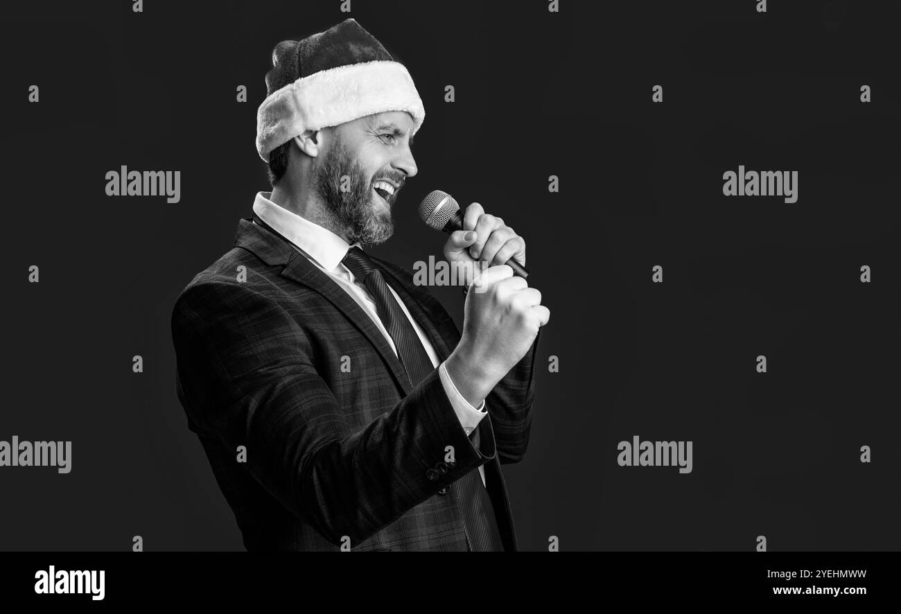 christmas event host man singing in santa hat, copy space. event host ...