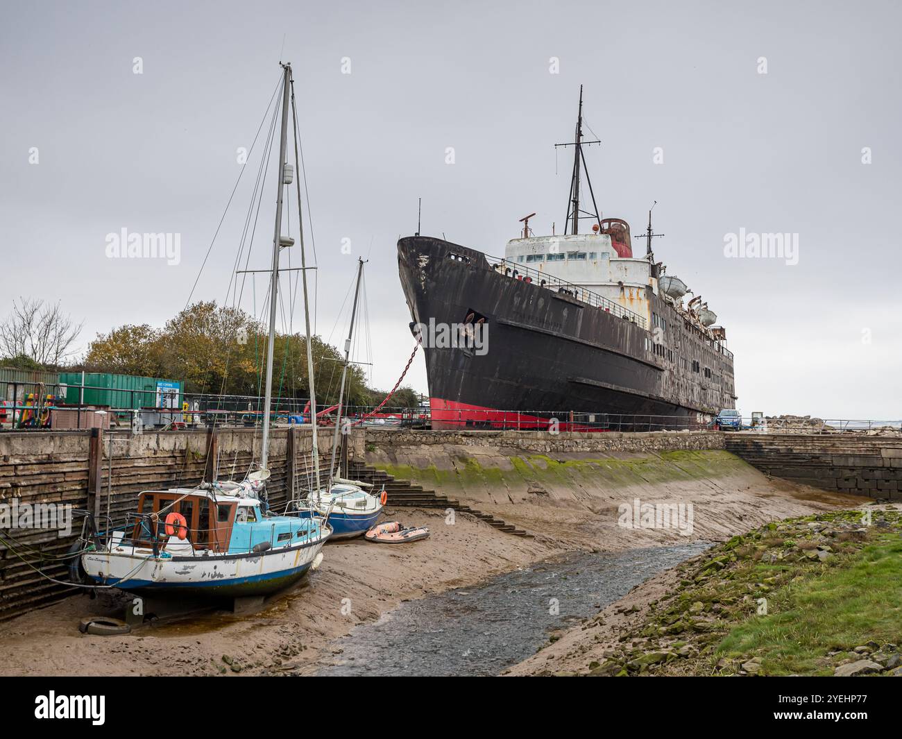 Duke of Lancaster ship dwarfs some smaller boats at Holywell in Wales ...