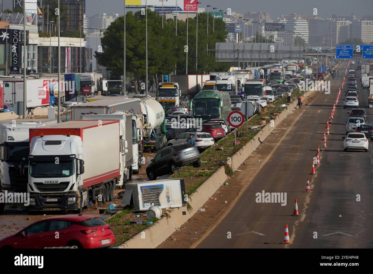 Vehicles are seen piled up and trapped after being swept away by floods ...