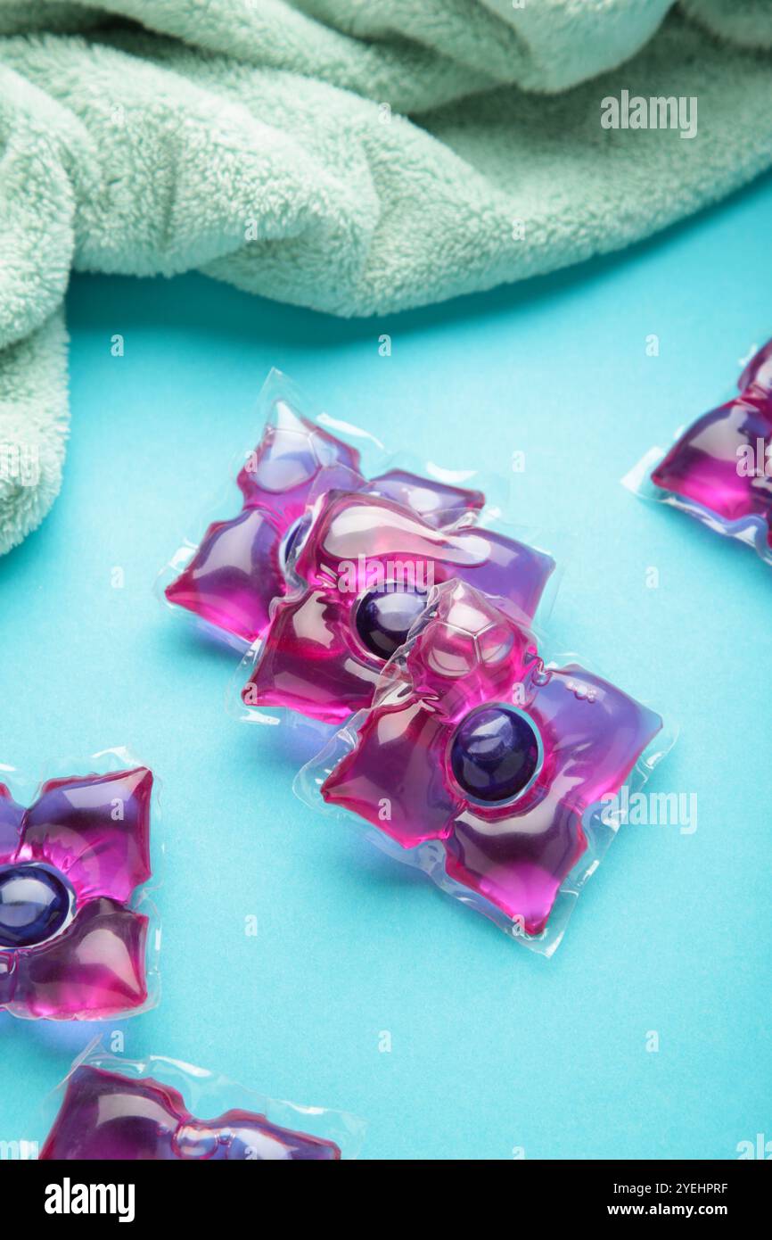 Laundry capsules with mint towel on blue background. Laundry detergent ...