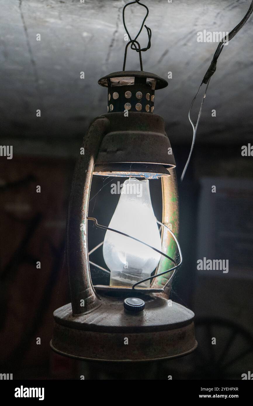 Kerosene lamp. Old metal lantern glass bulb in basement dark Stock ...
