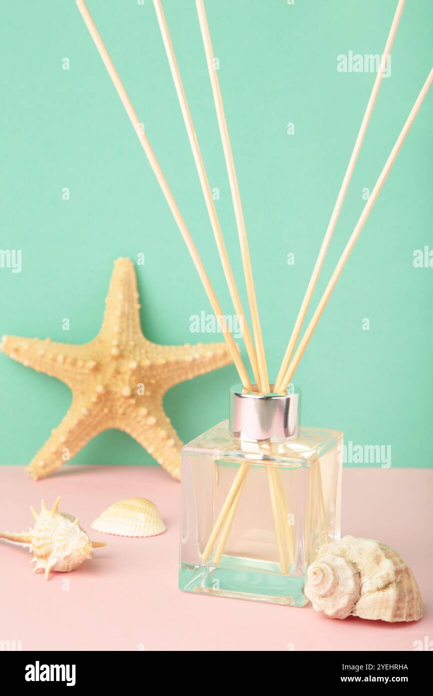 Reed diffuser and sea shells on mint background. Vertical photo. Top view Stock Photo - Alamy
