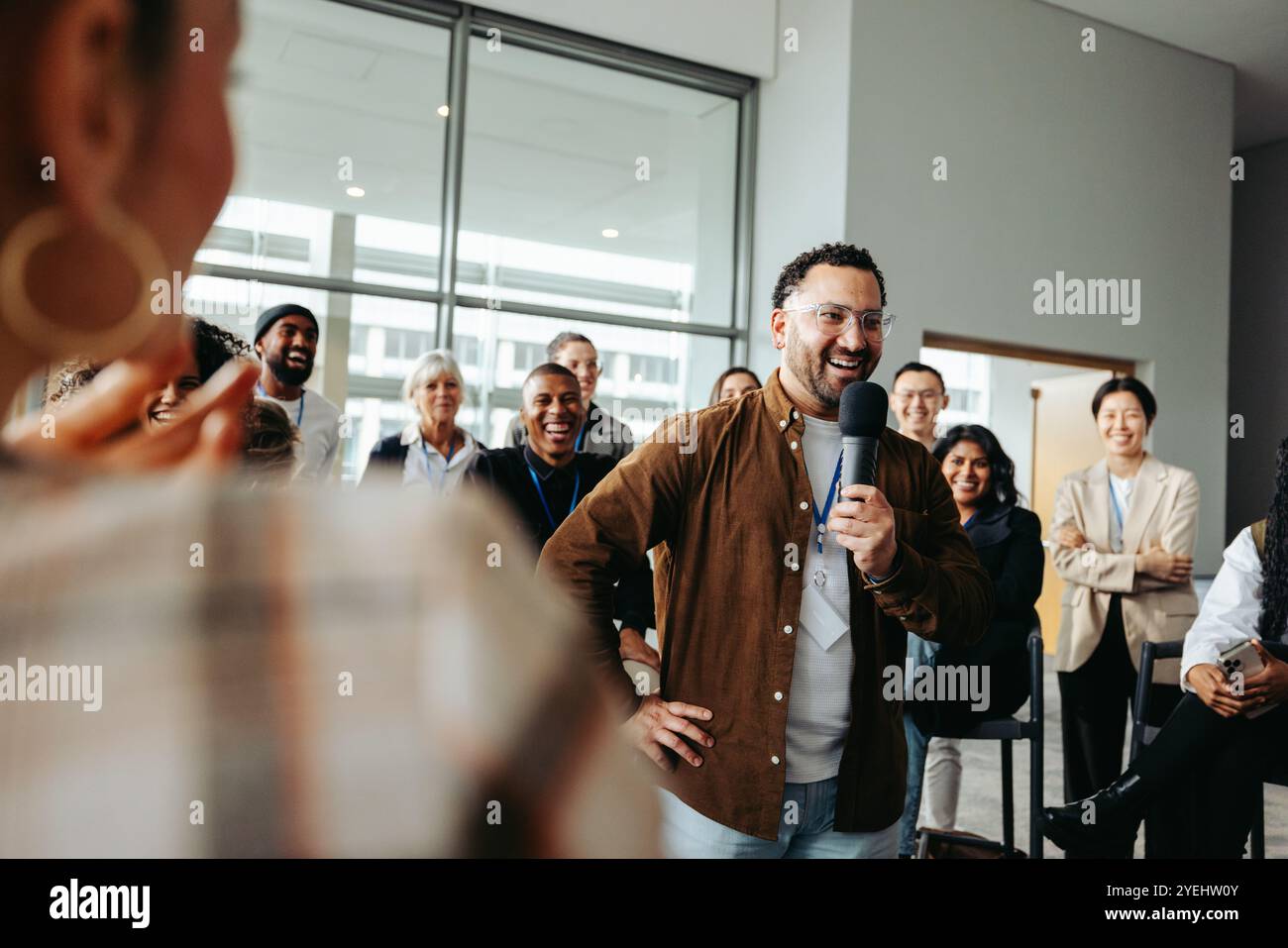 Team leader engaging with group during a meeting in a modern office, promoting collaboration and ...