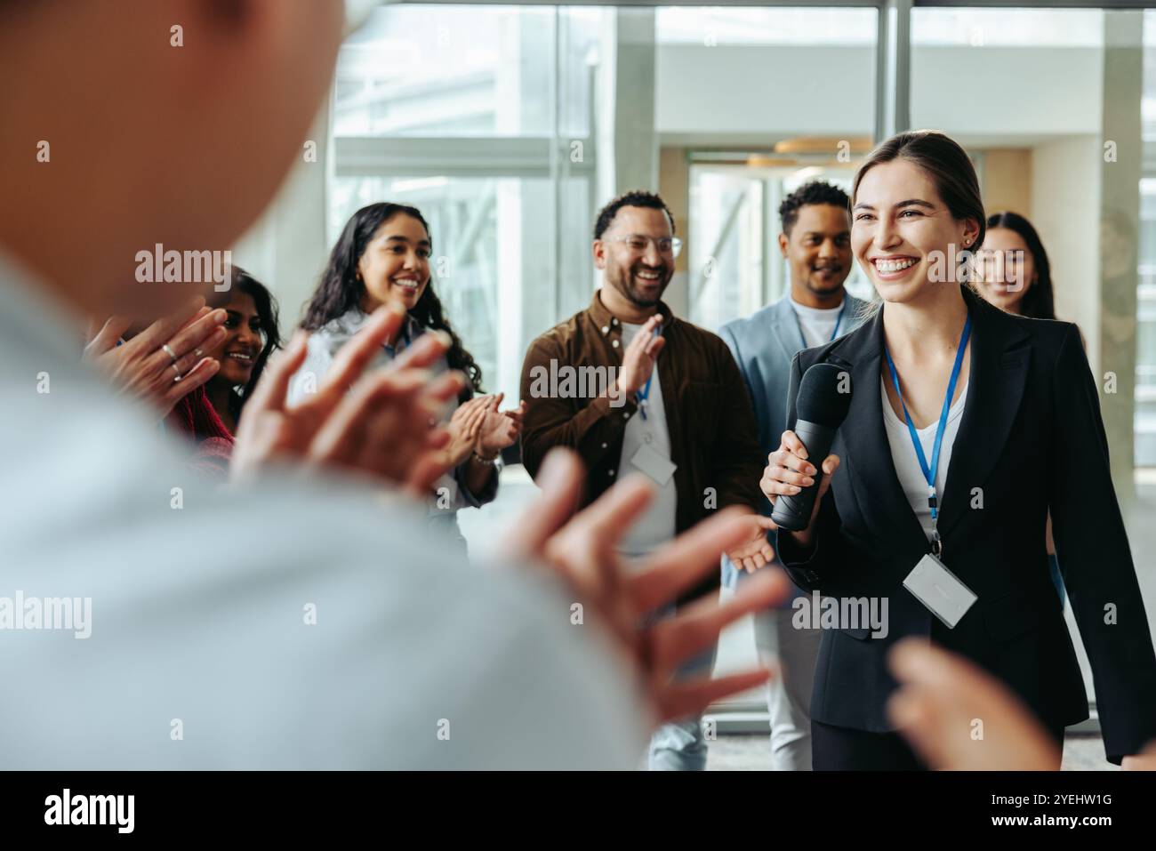 A female leader is applauded during a successful business meeting ...