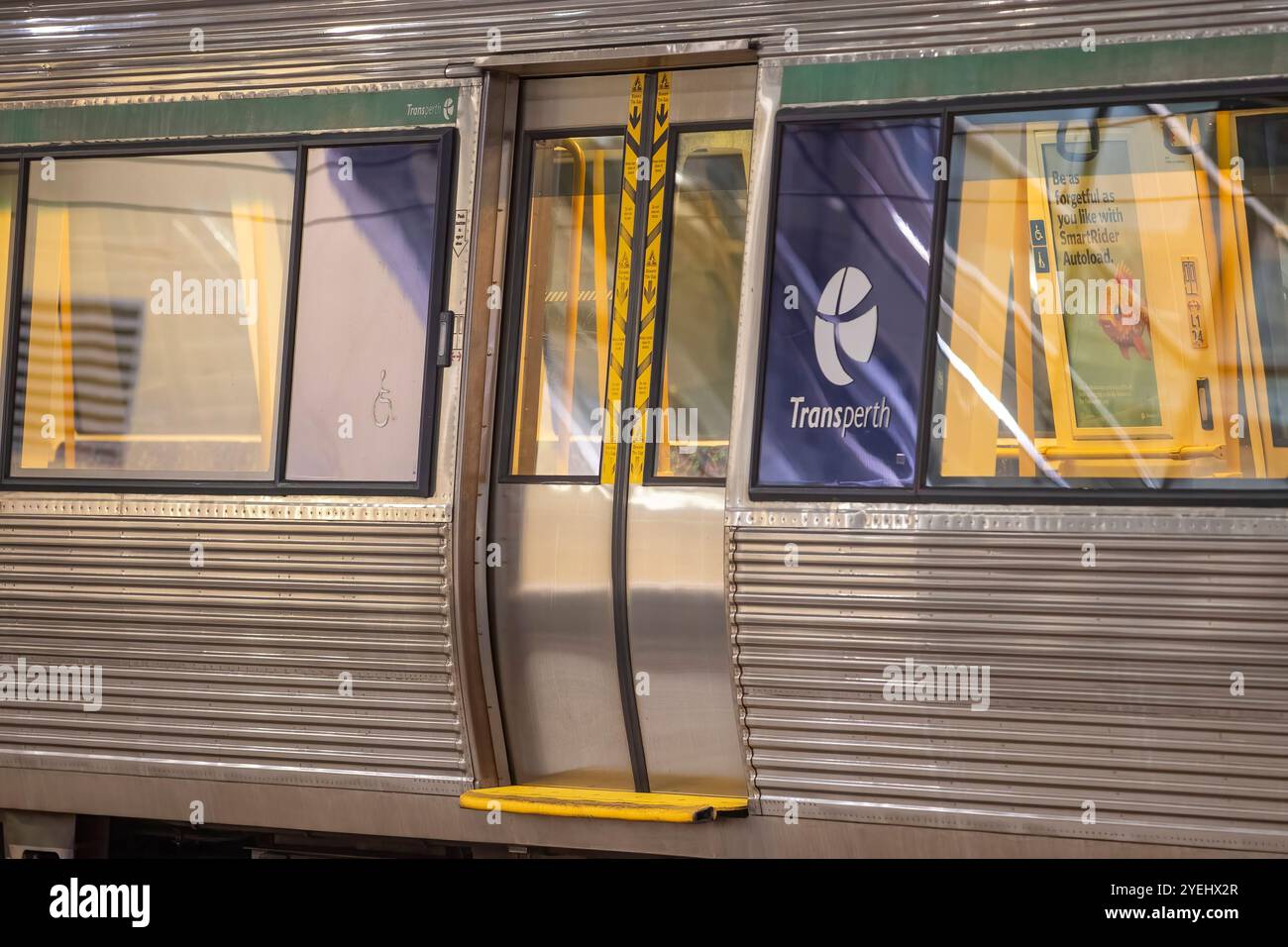 A close-up of a Transperth train carriage, focusing on the train door ...
