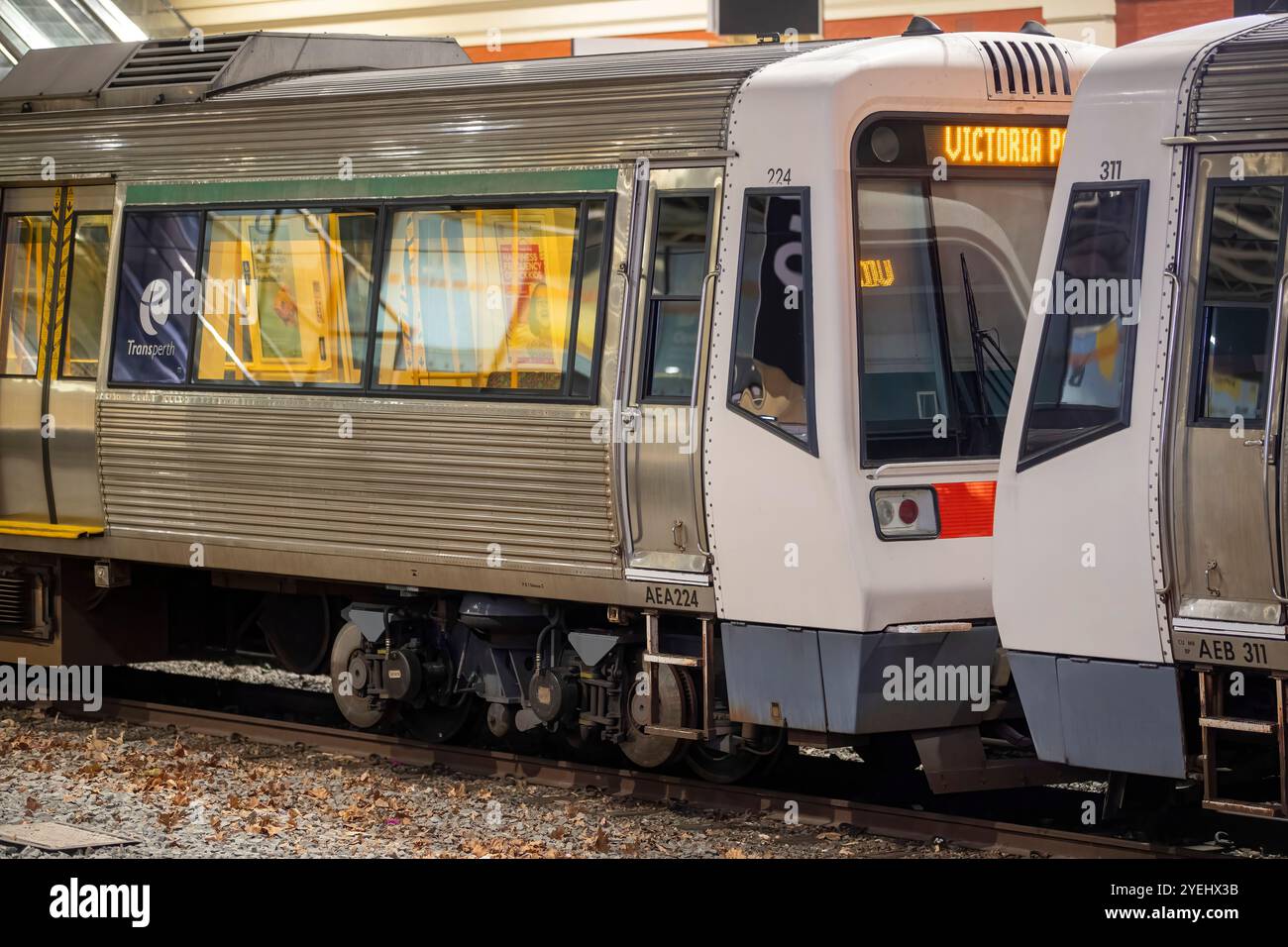 A side view of a Transperth train at the station, featuring two ...