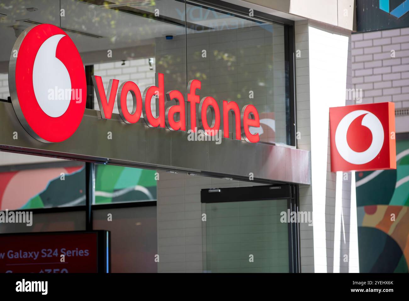 A Vodafone storefront with a prominent red logo and signage displayed ...