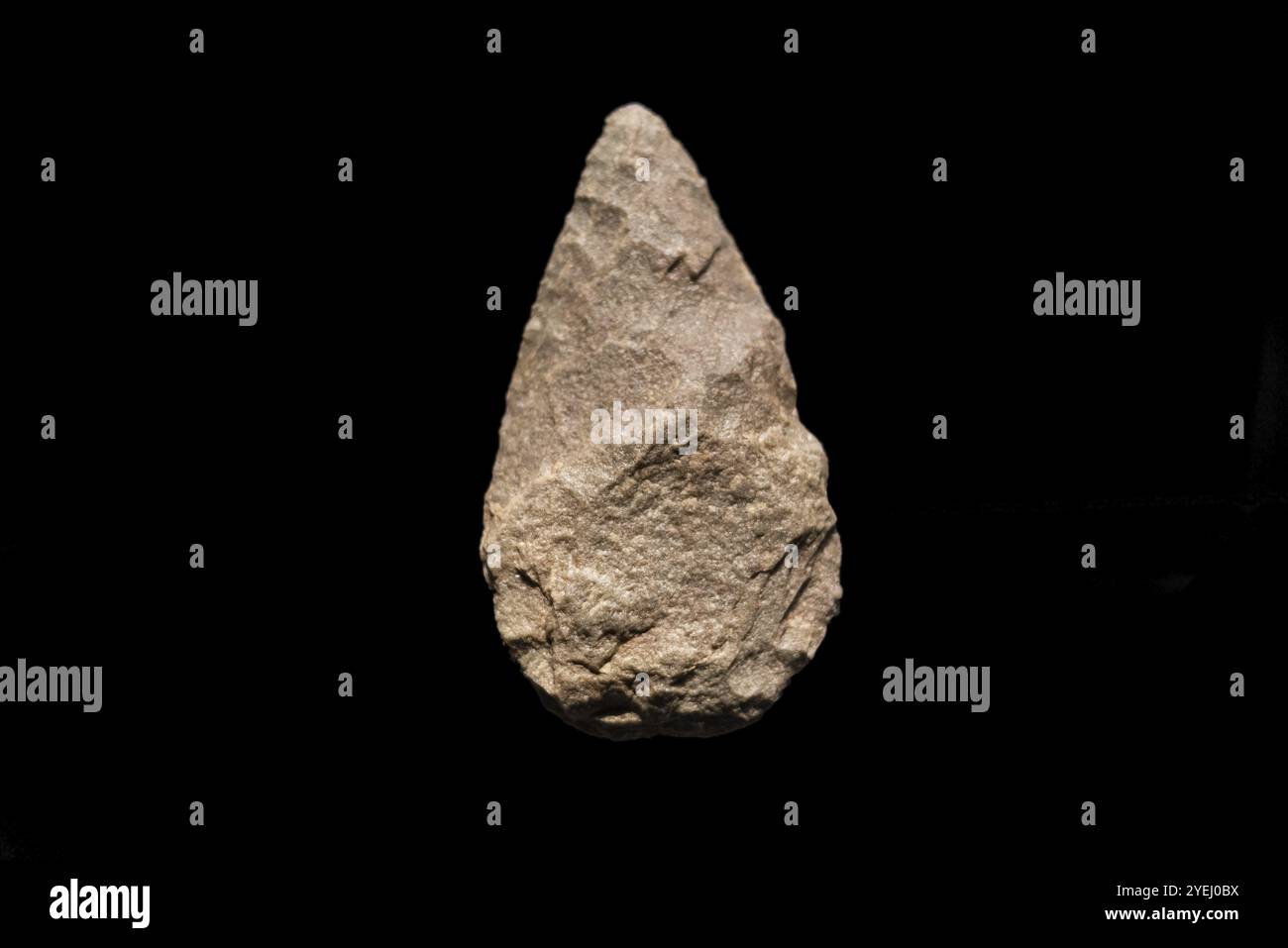 Prehistoric human tool, Quartzite biface on black isolated background ...