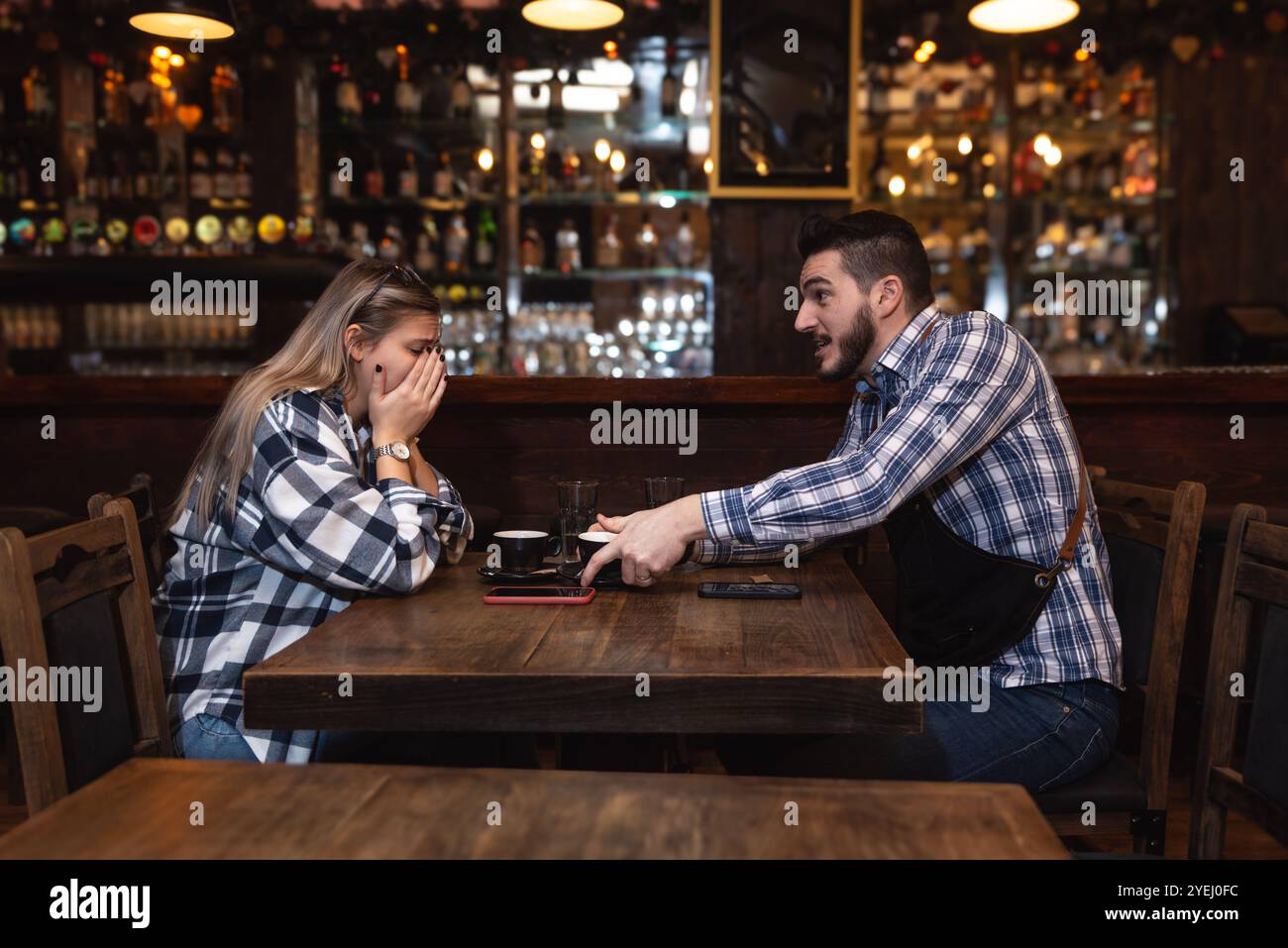 Bartender life. Two young bartenders argue about coffee taste and ...