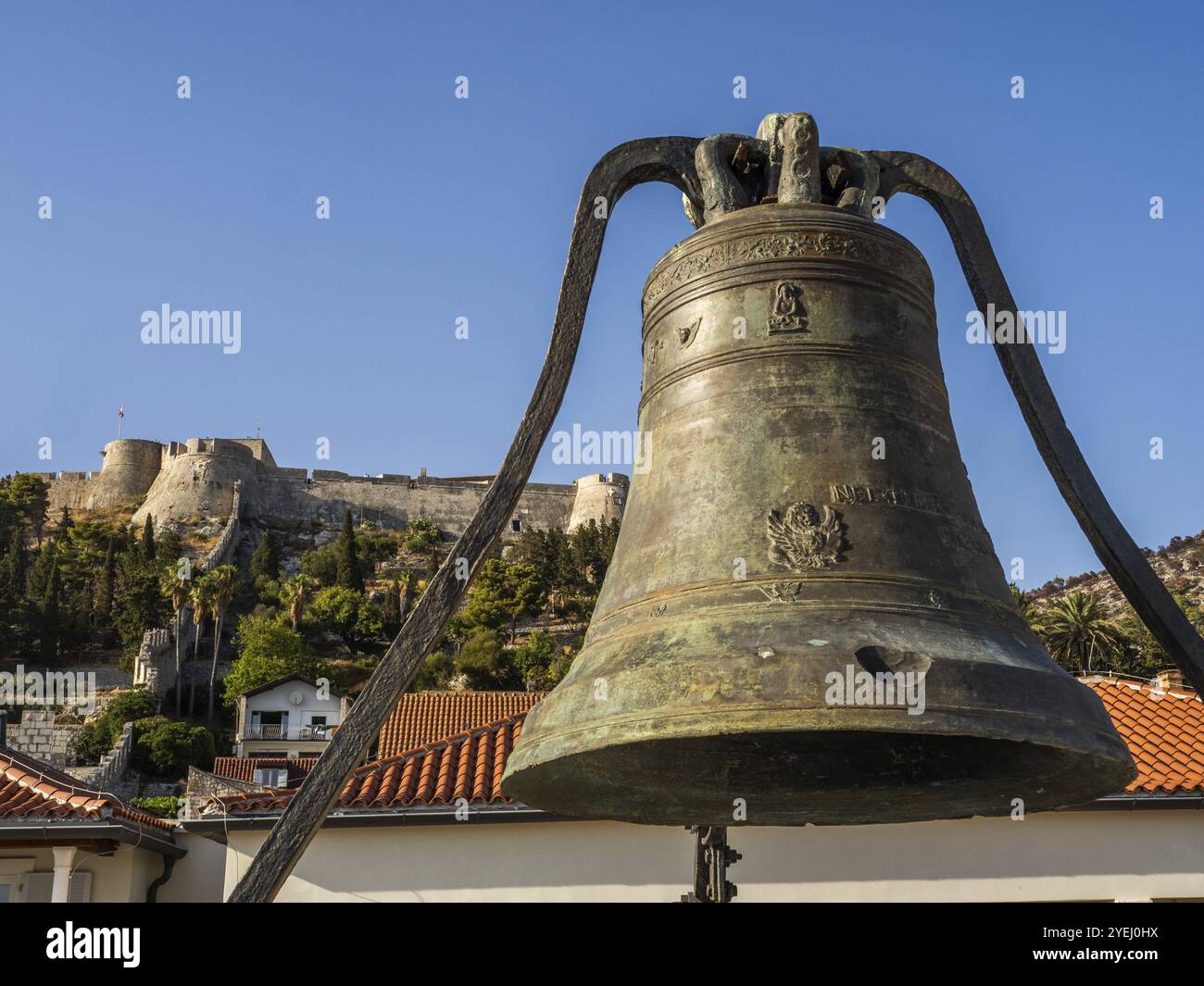 Church bell, Spanish fortress at the back, town of Hvar, island of Hvar ...