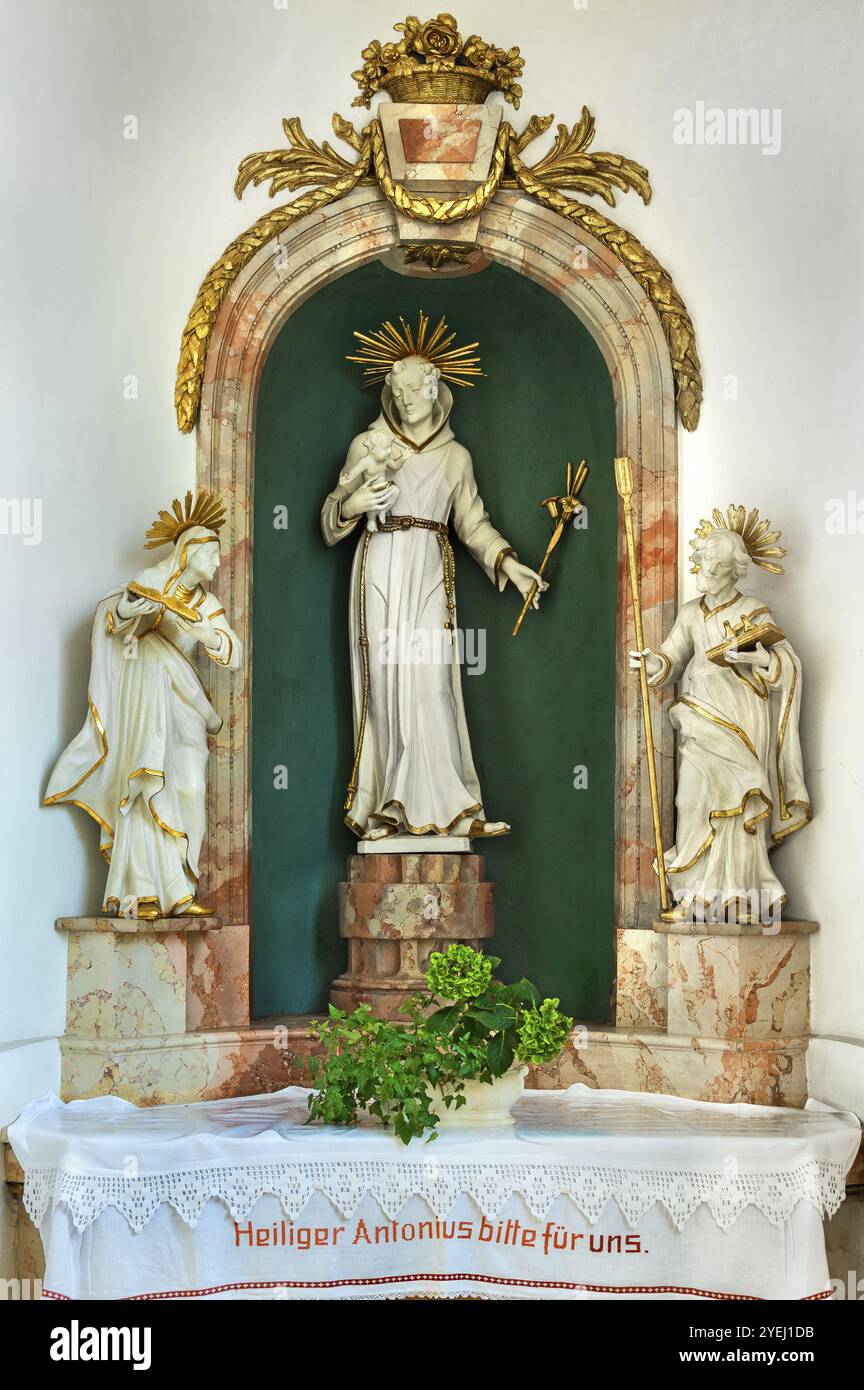 Side altar with three figures of saints in the Roman Catholic Church of ...