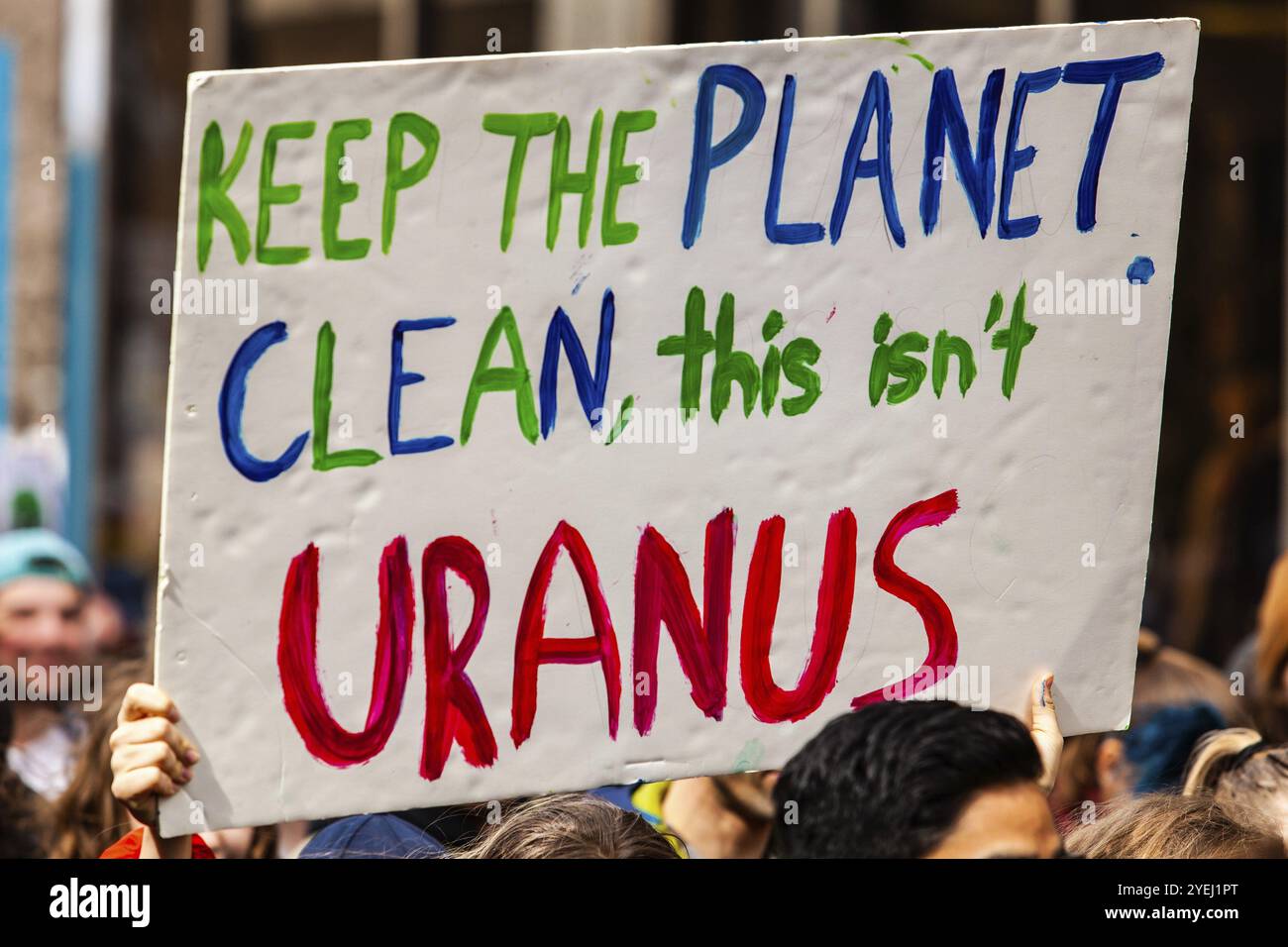 A colorful poster is viewed up close, saying keep the planet clean ...