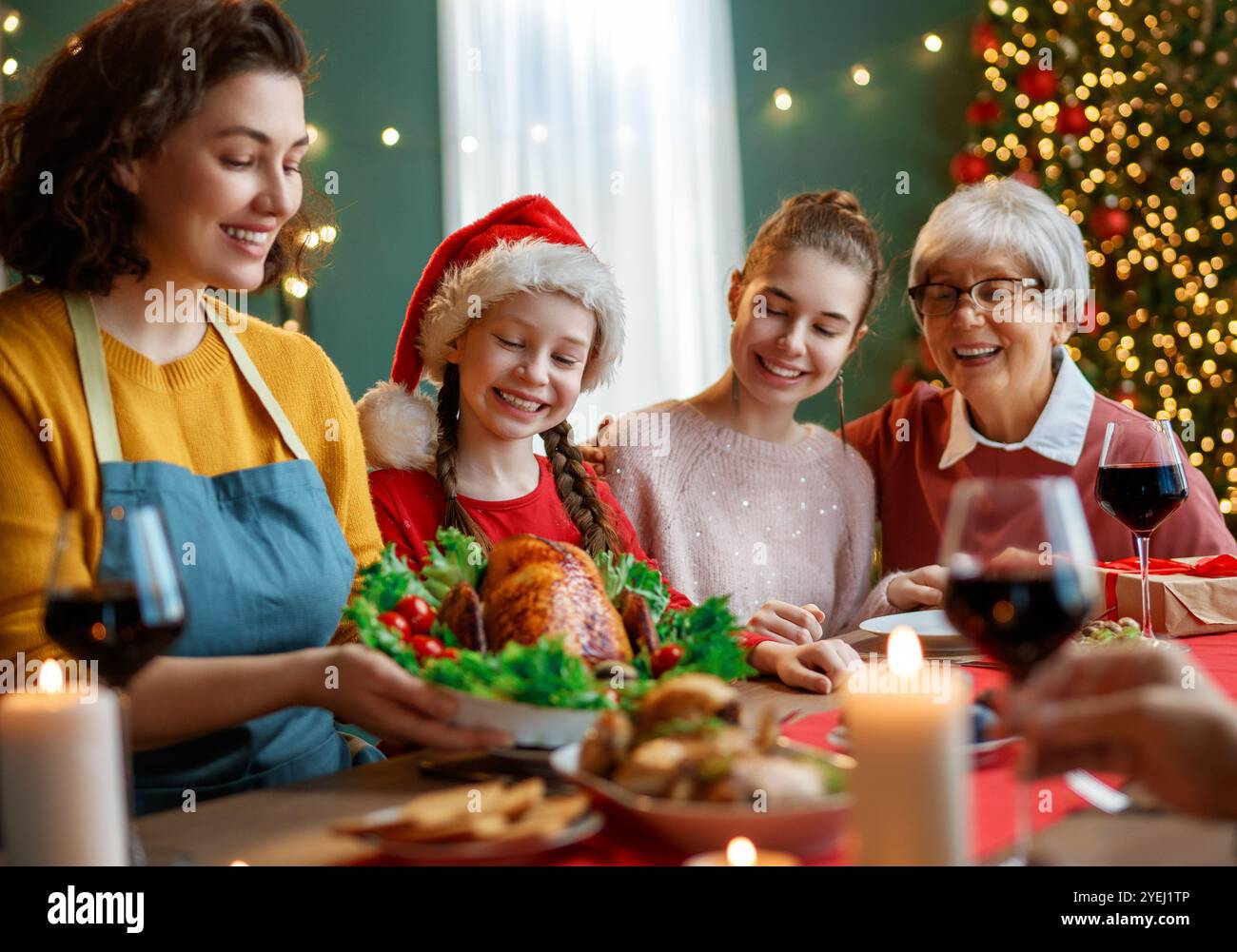 Merry Christmas. Happy family are having dinner at home. Celebration holiday and togetherness ...