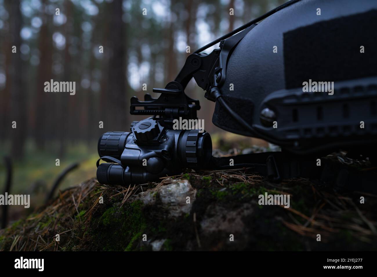 Night vision device mounted on a tactical helmet, photo in the forest ...