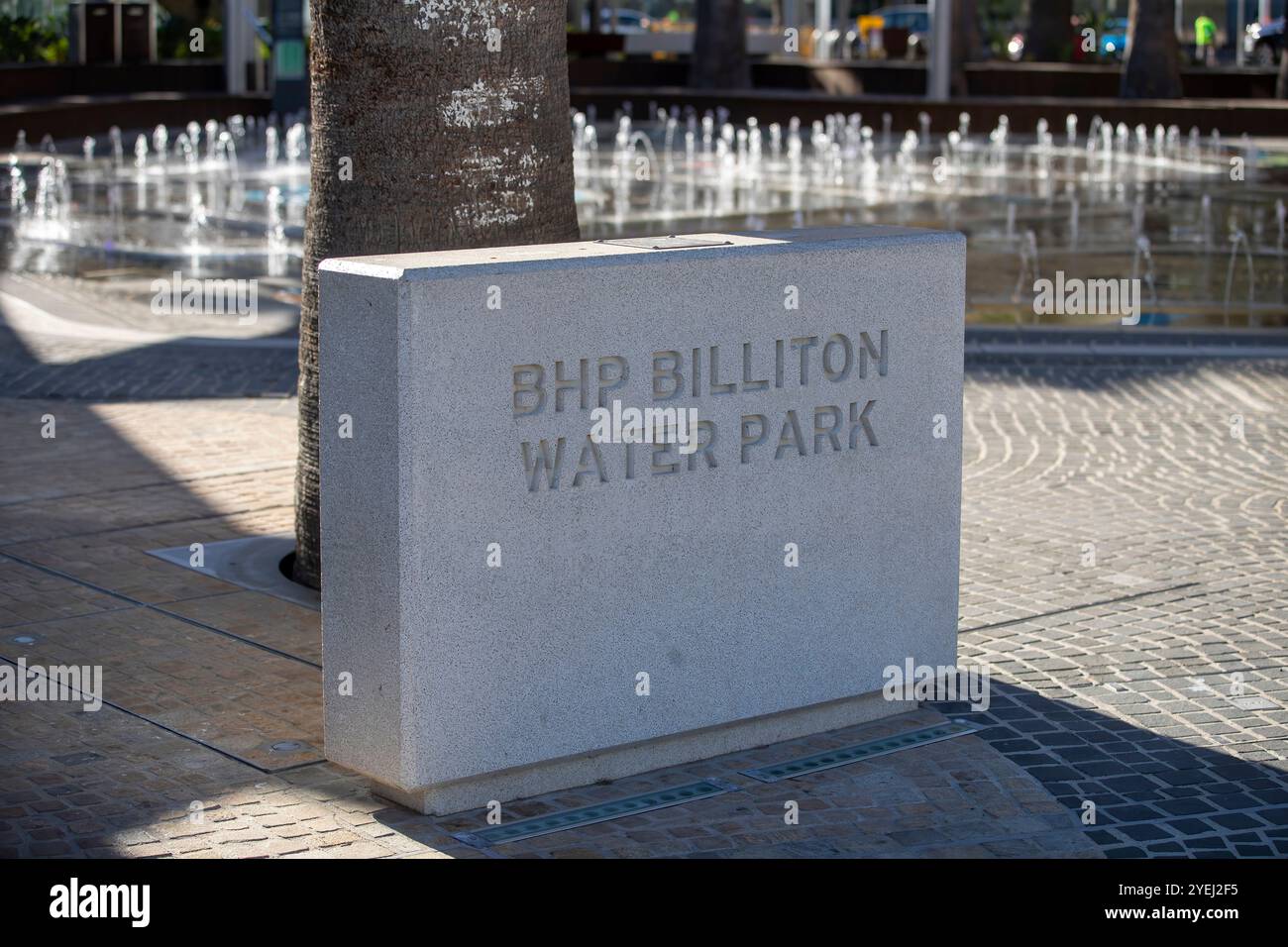 A stone plaque marking the entrance to BHP Billiton Water Park, with a ...