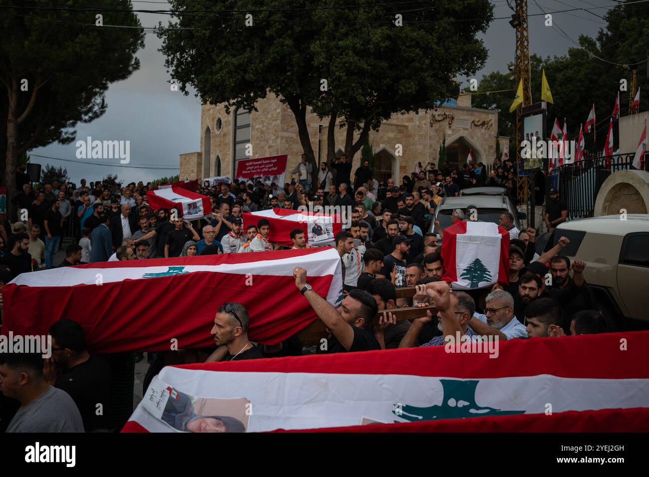 Shia Muslims carry the coffins during a funeral of over 10 people ...