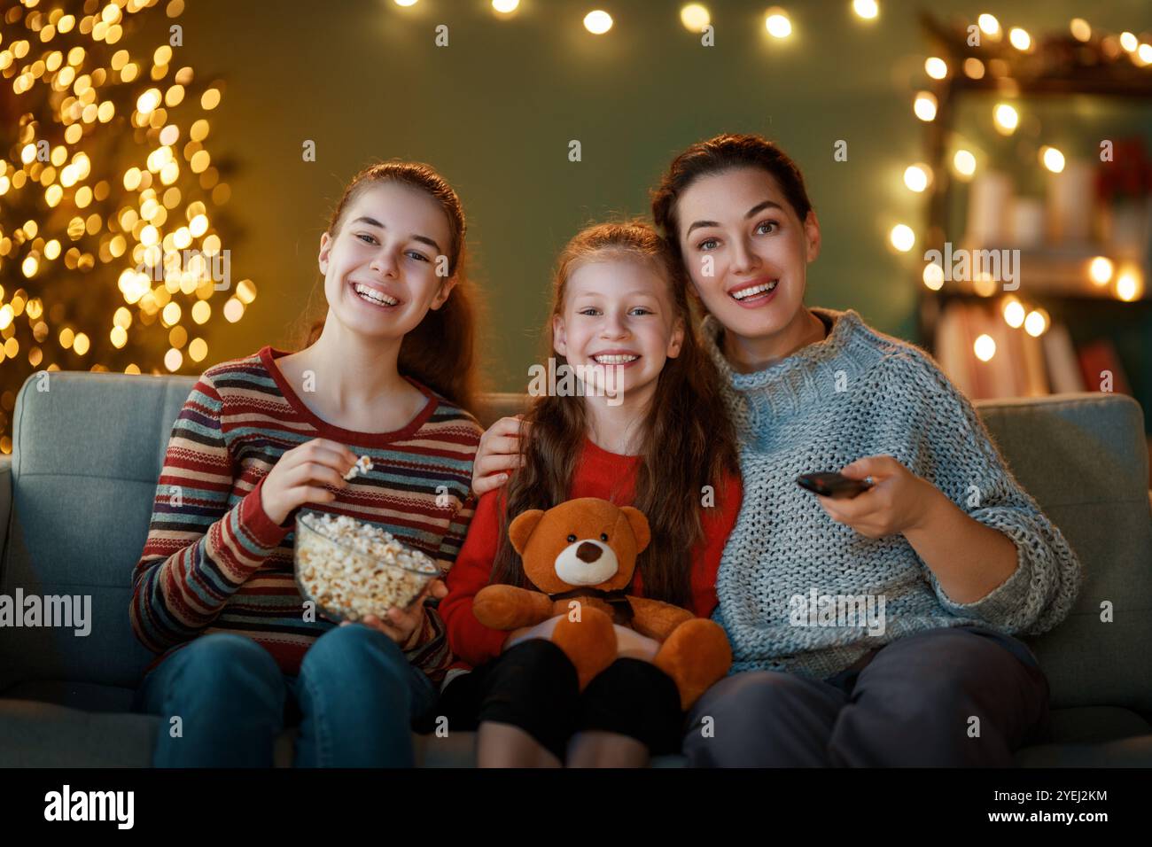 Merry Christmas and Happy New Year. People having fun near tree indoors ...