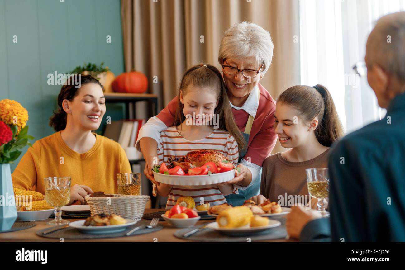 Happy Thanksgiving Day. Autumn feast. Family sitting at the table and ...