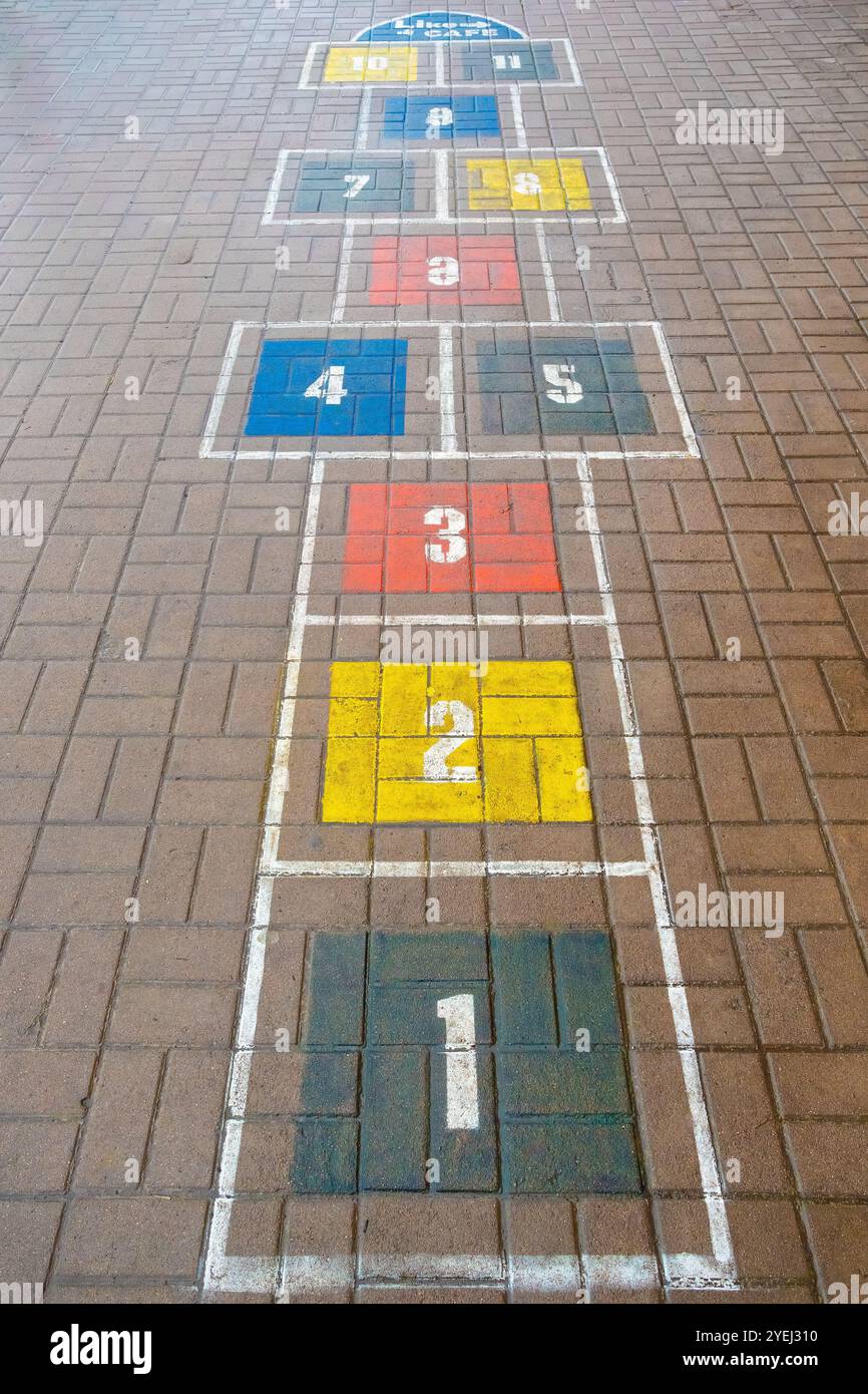 A game of colorful classics on a brick path. Brightly painted brick ...