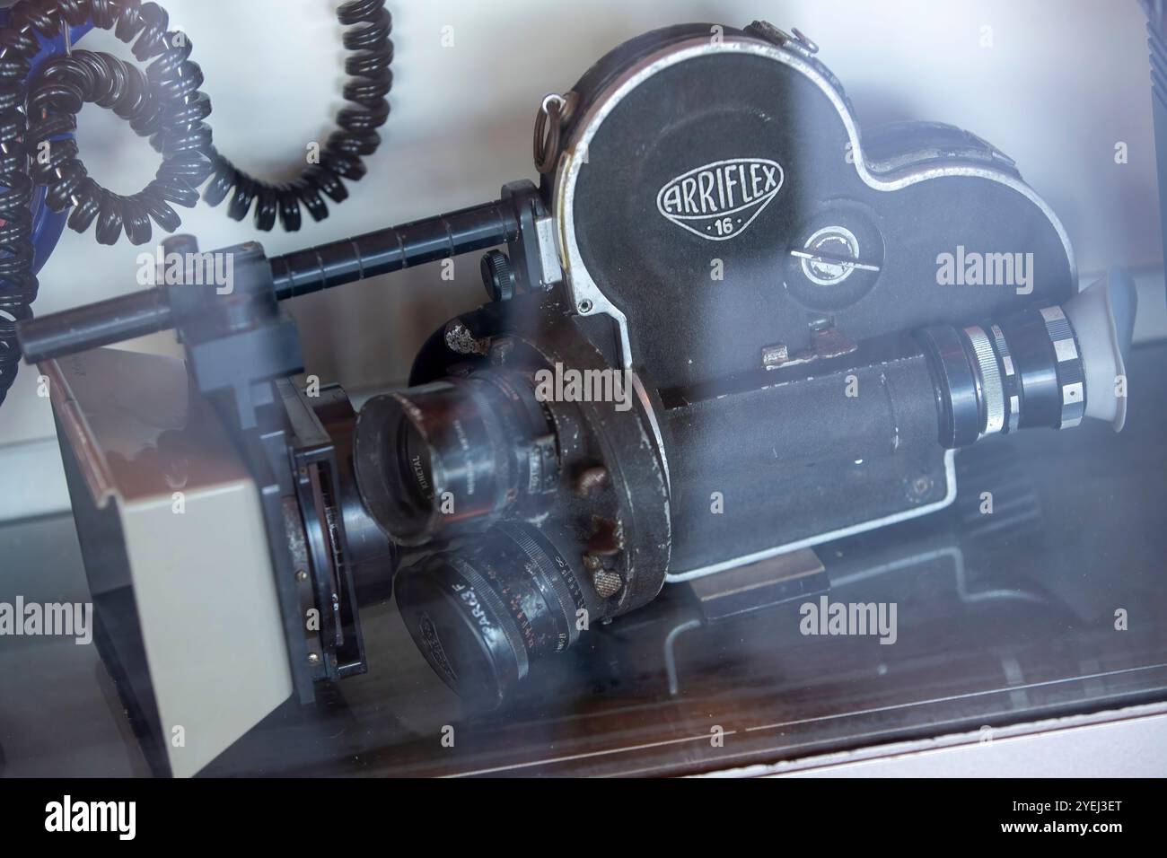 The photo features a vintage Arriflex 16mm film camera, known for its ...