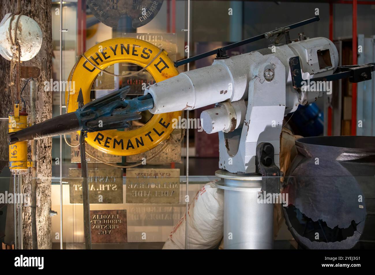 A harpoon gun displayed in a museum exhibit, with a life preserver ...