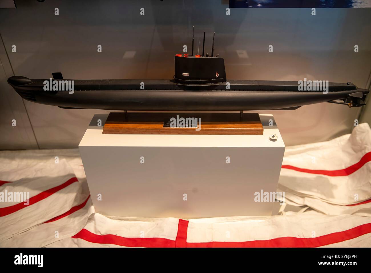 A scale model of a submarine displayed on a wooden stand in a museum ...
