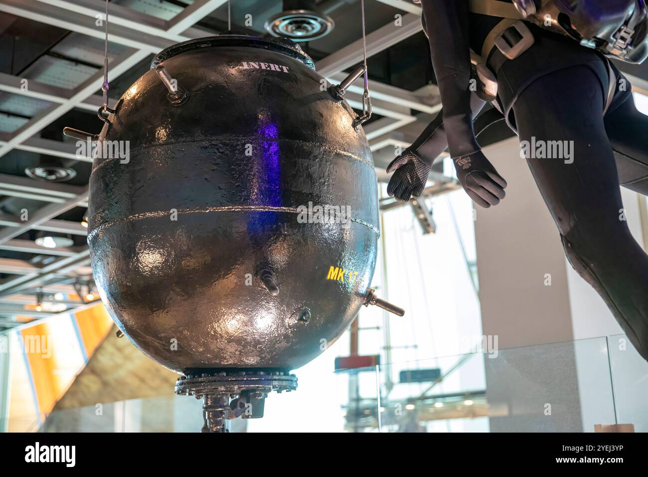 This photograph displays an inert naval mine, a spherical metallic ...